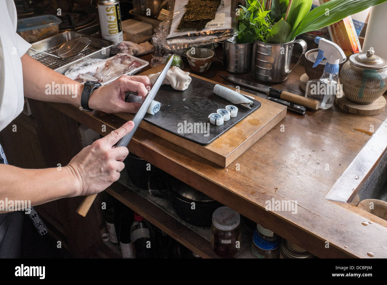 Japanese chef preparing traditional Japanese food in a traditional ...