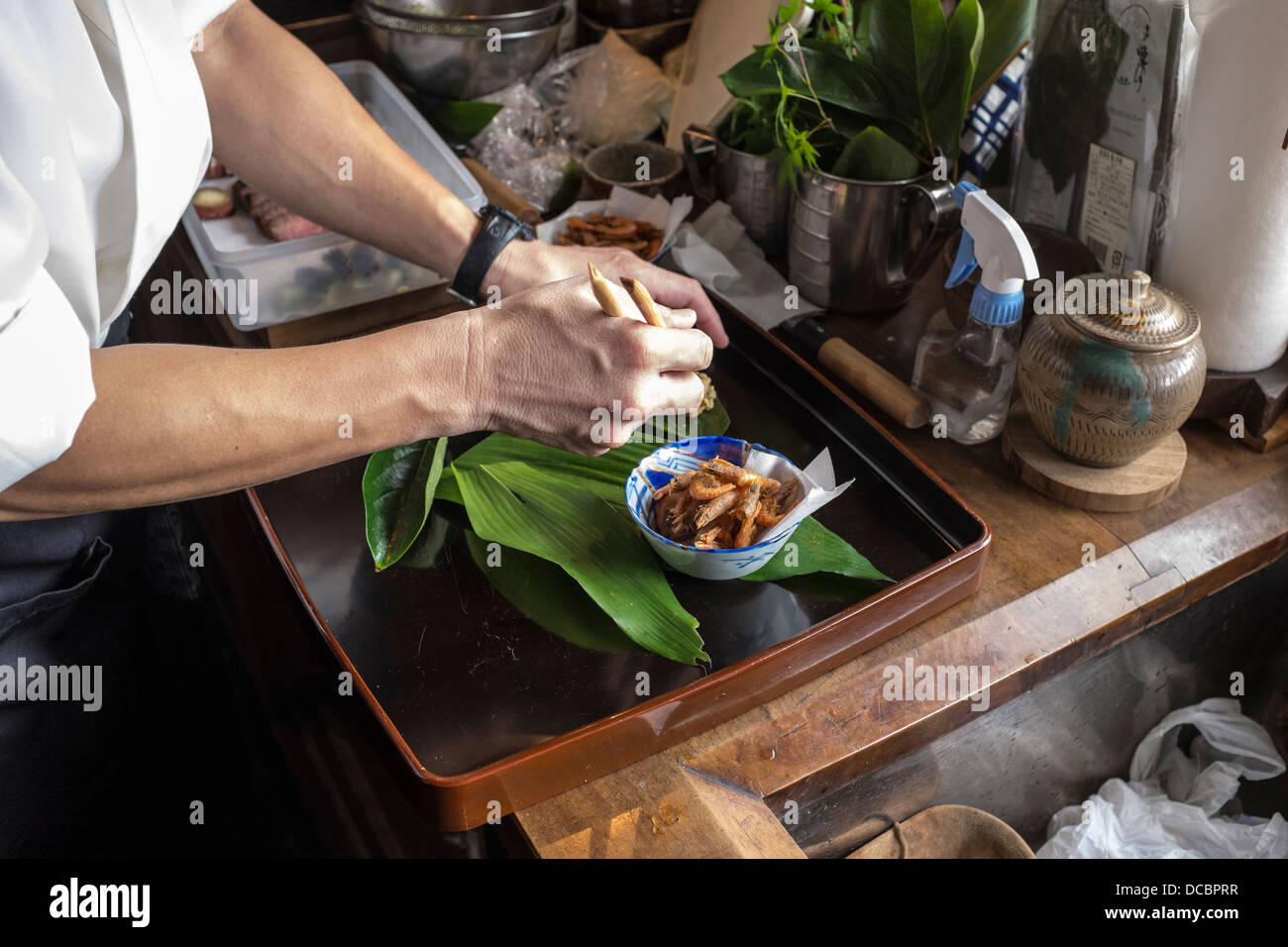 Japanese chef preparing traditional Japanese food in a traditional ...