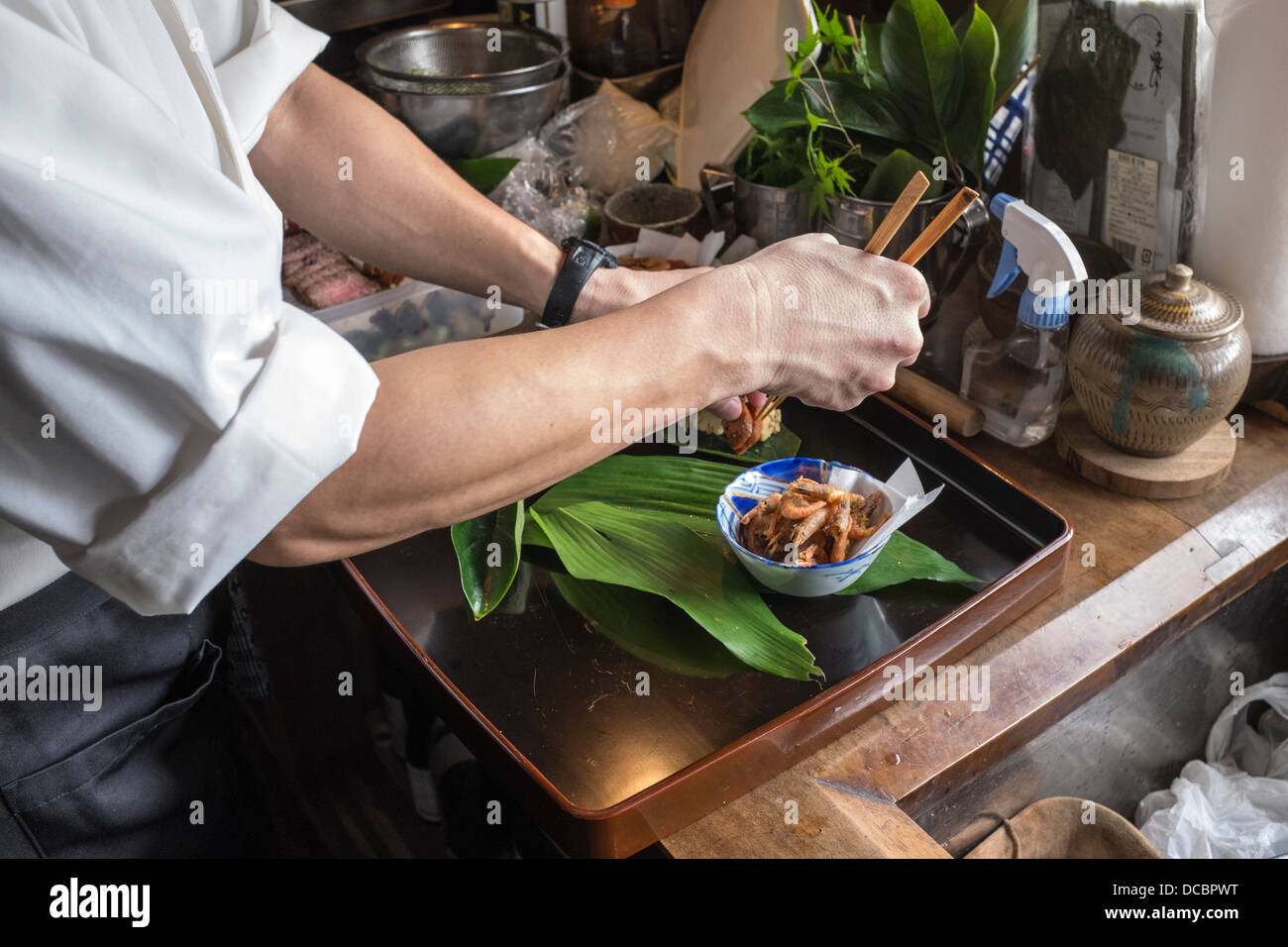 Japanese chef preparing traditional Japanese food in a traditional ...