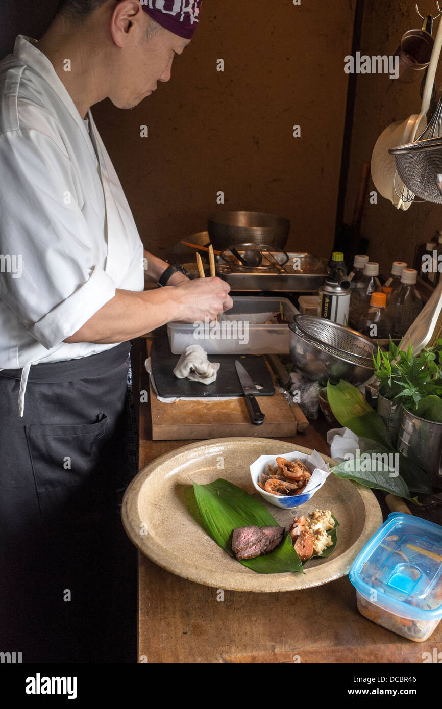 Japanese chef preparing traditional Japanese food in a traditional ...