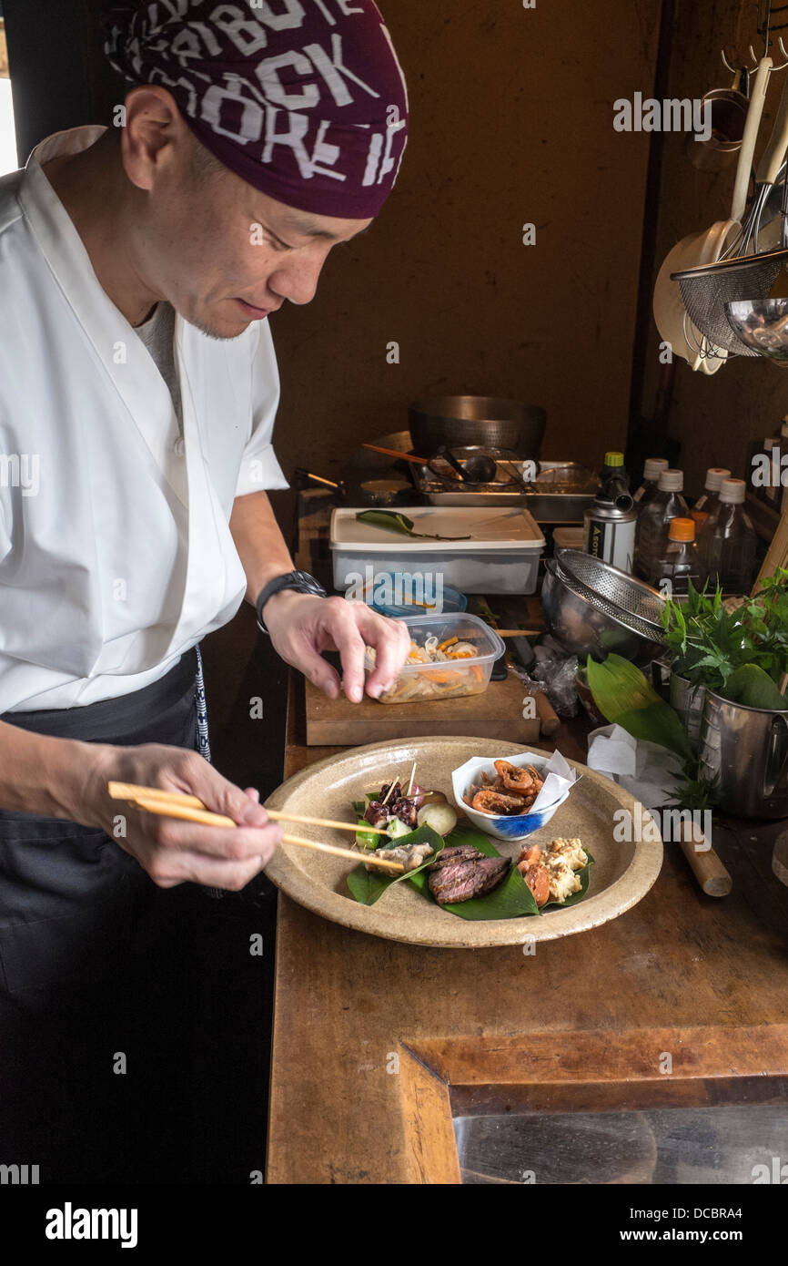 Japanese chef preparing traditional Japanese food in a traditional ...
