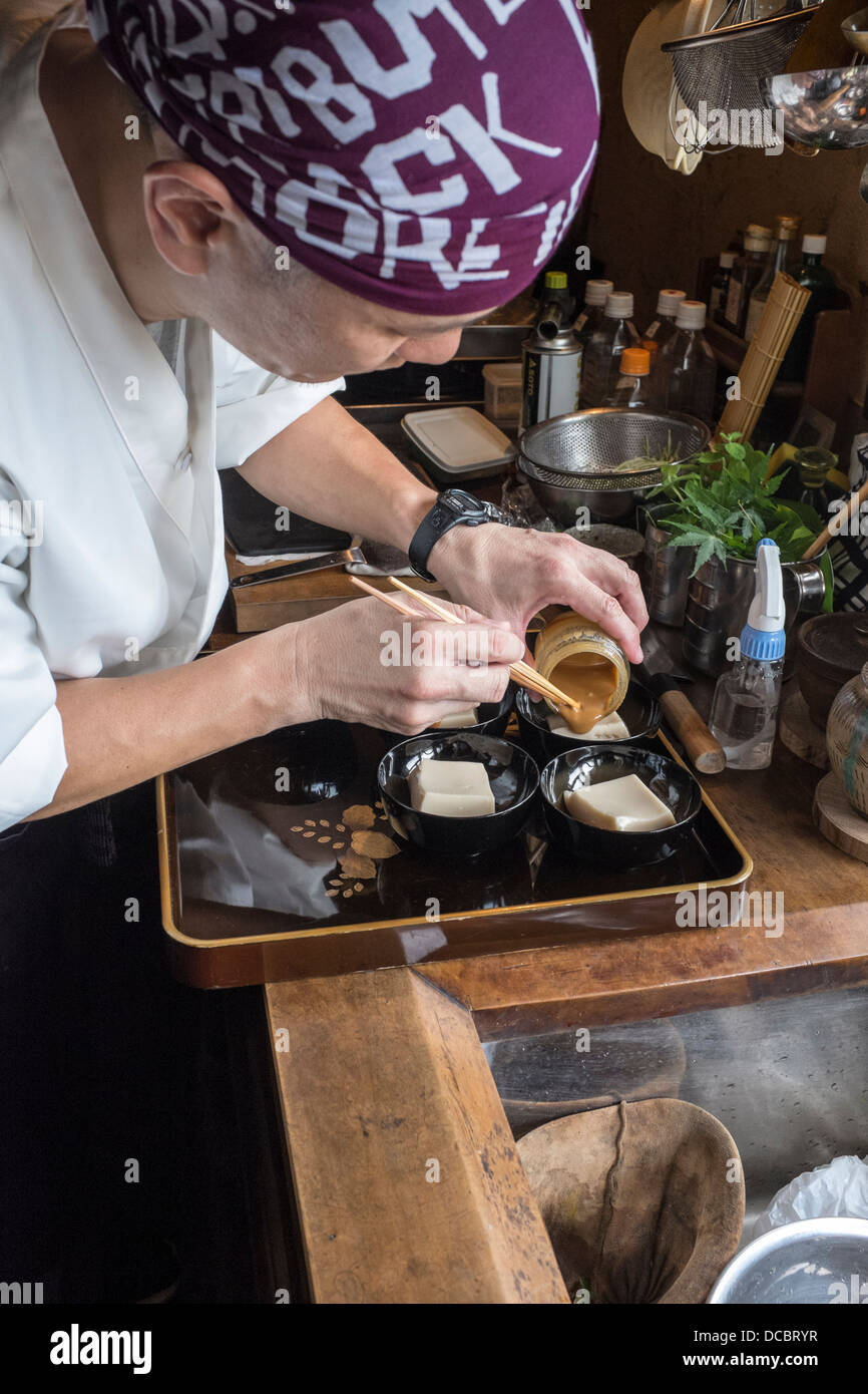 Japanese chef preparing traditional Japanese food in a traditional ...