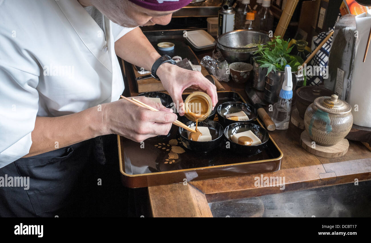 Japanese chef preparing traditional Japanese food in a traditional ...