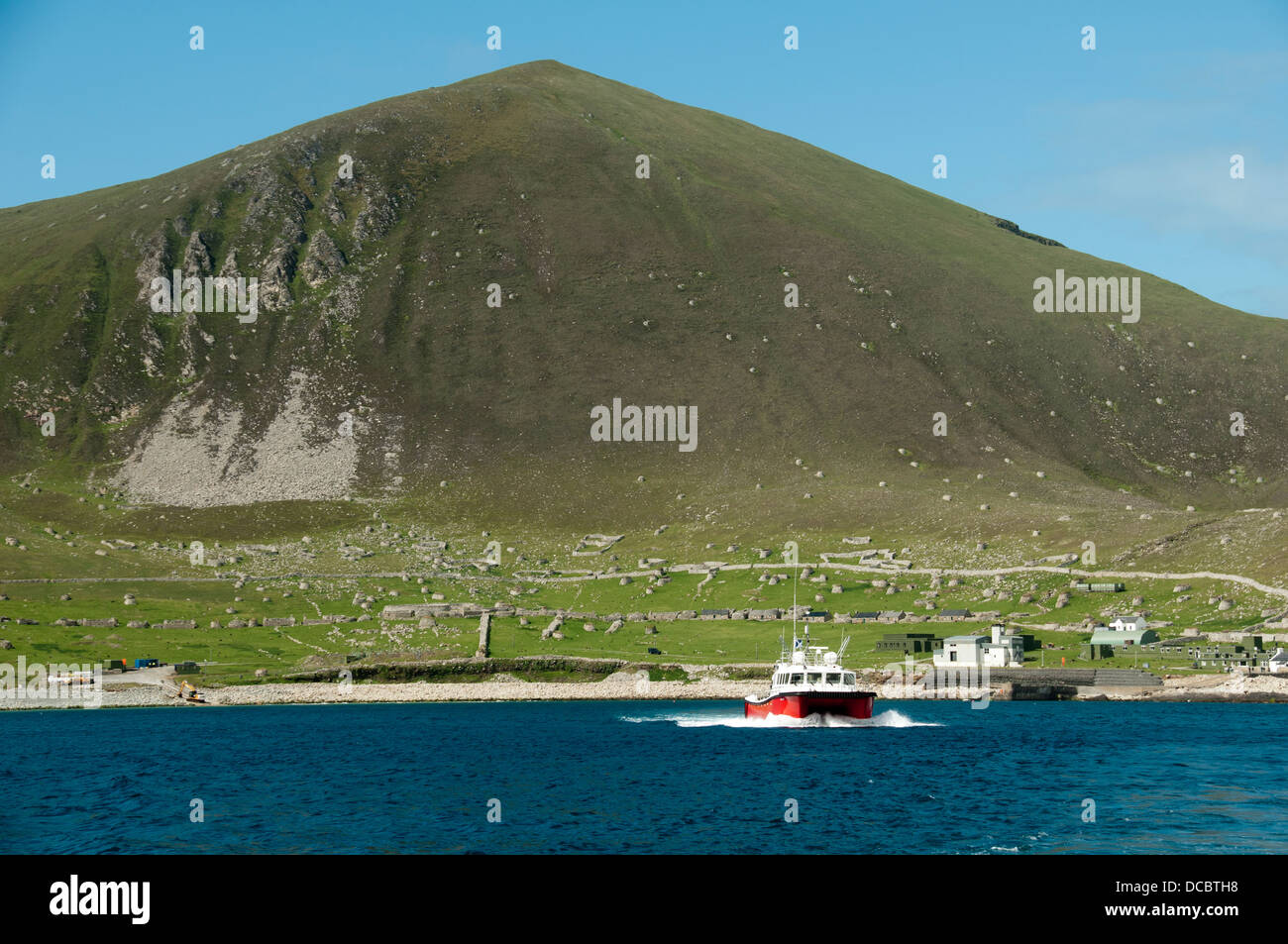 Tourist boat in Village Bay, Hirta, with the peak of Conachair behind ...