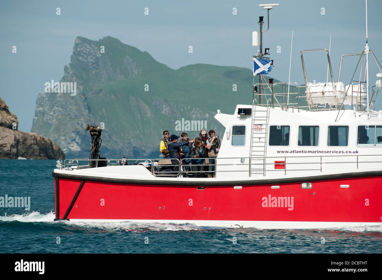 Tourist boat in Village Bay, Hirta, with the island of Boreray behind ...
