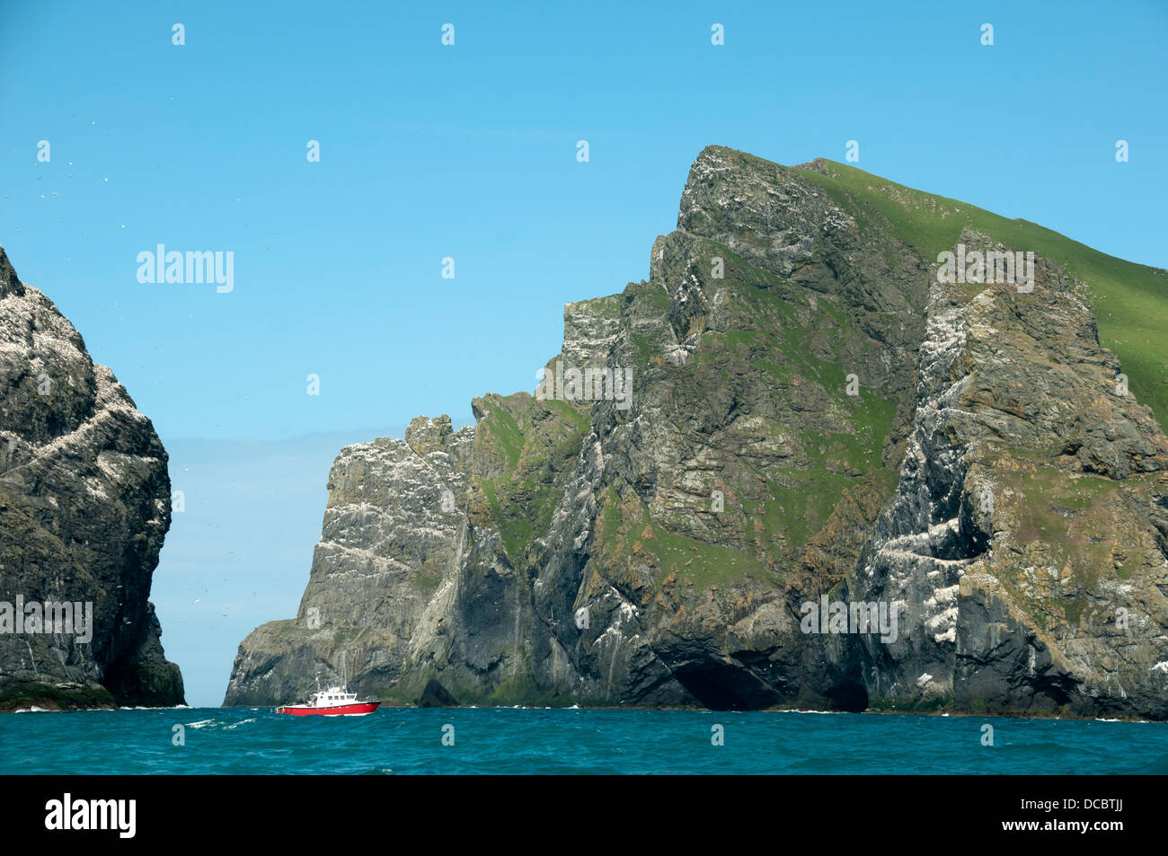 Tourist boat approaching the island of Boreray, St Kilda archipelago ...