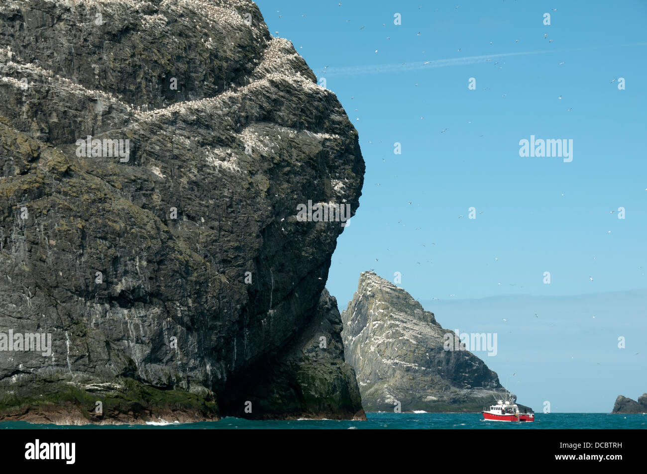 Tourist boat below Stac Lee, St Kilda archipelago, Outer Hebrides ...