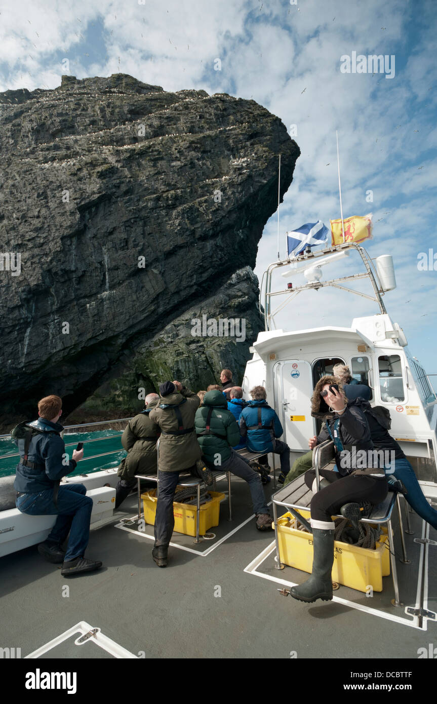 Tourist boat approaching Stac Lee, St Kilda archipelago, Outer Hebrides ...