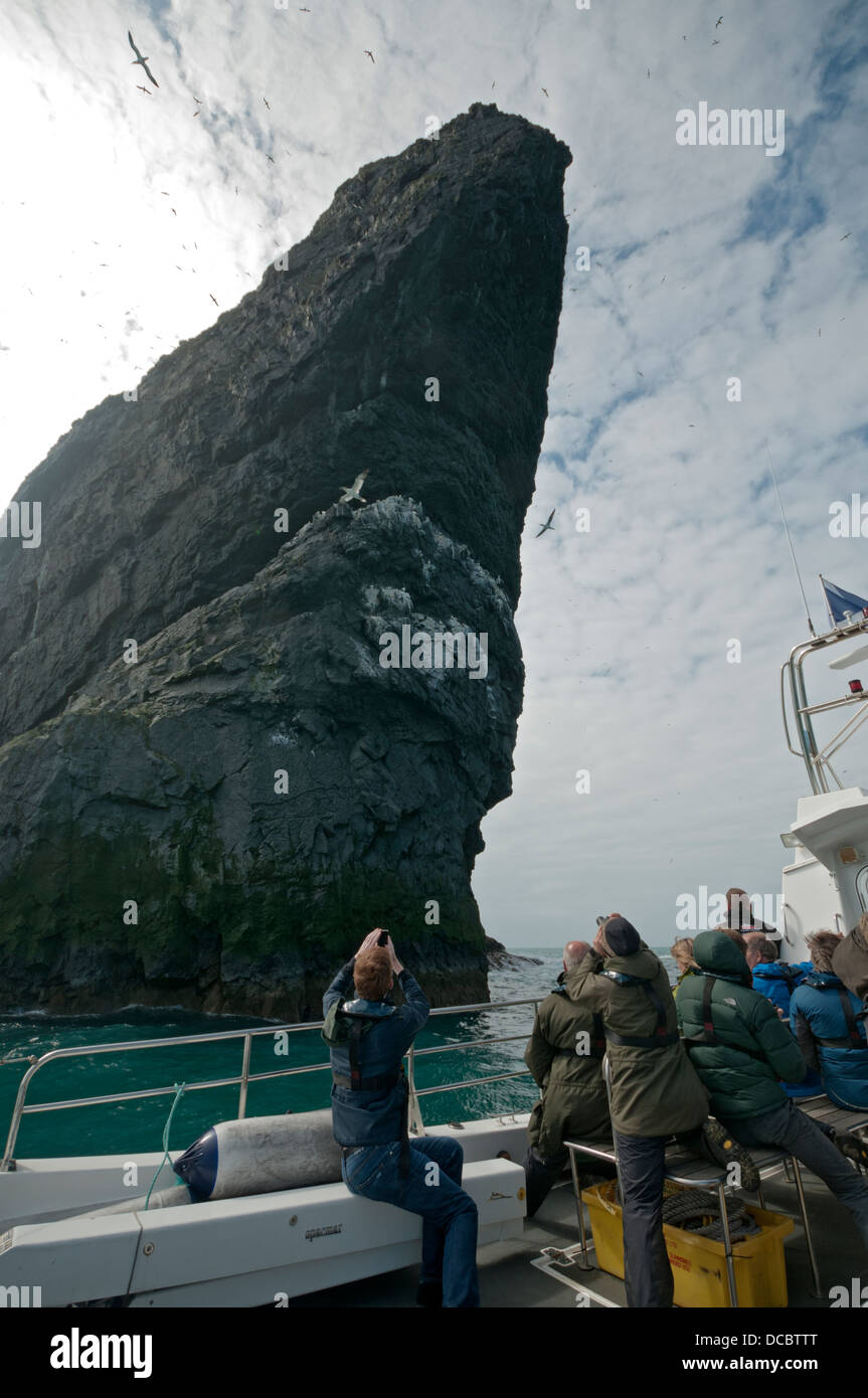 Tourist boat approaching Stac Lee, St Kilda archipelago, Outer Hebrides ...