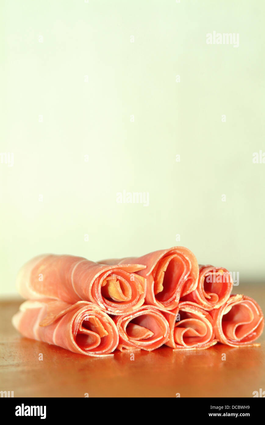 sliced ham rolled on a timber plate Stock Photo - Alamy