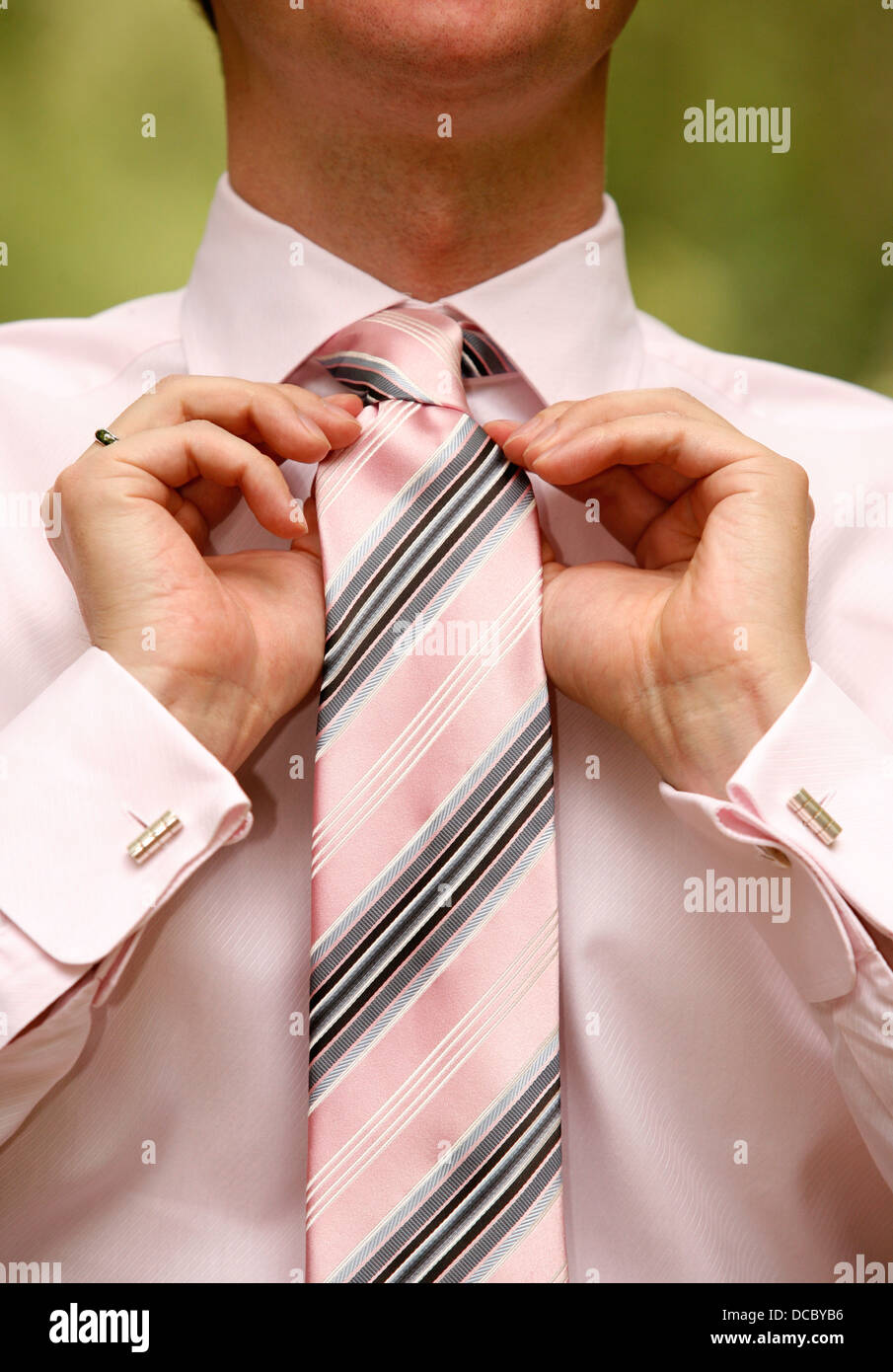 Man tying necktie Stock Photo - Alamy