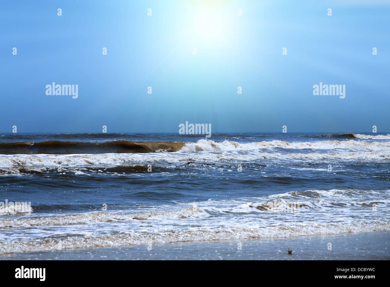 Sun shining over ocean shore Stock Photo - Alamy