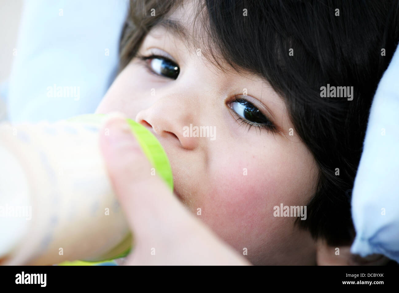 Baby boy drinking from bottle Stock Photo - Alamy