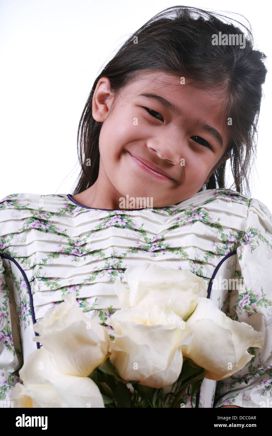 Asian child holding white roses Stock Photo - Alamy