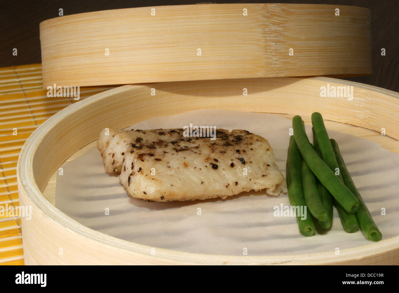 vietnamese river cobbler fillet in a bamboo steamer Stock Photo - Alamy