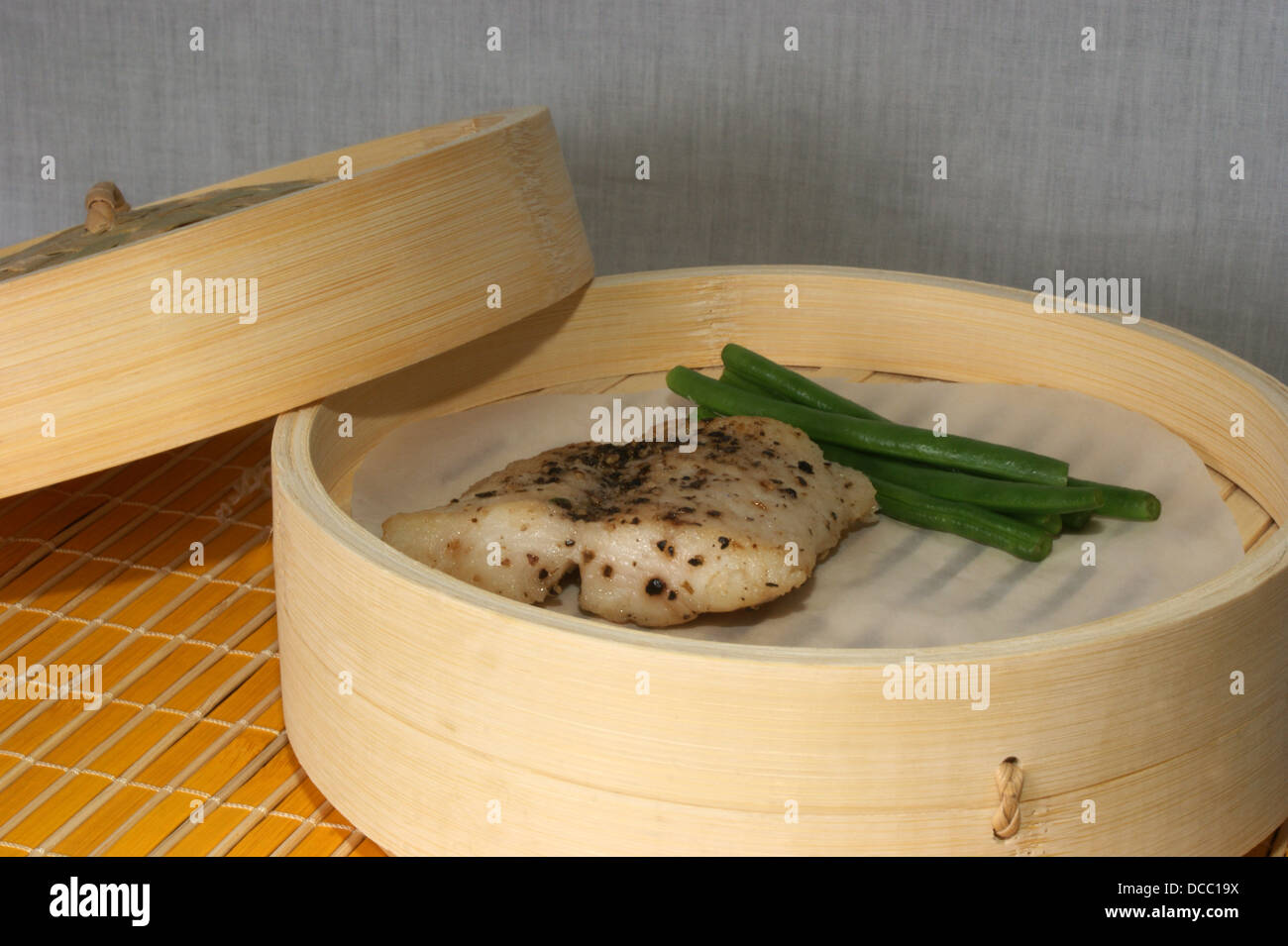 vietnamese river cobbler fillet in a bamboo steamer Stock Photo - Alamy