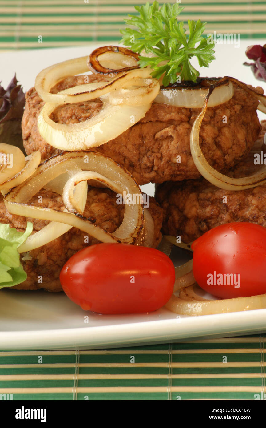 rissole with grilled organic onion and parsley on a plate Stock Photo ...