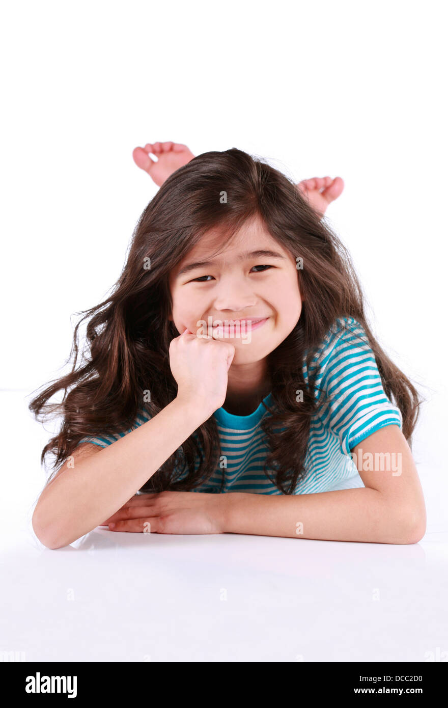 Happy little girl lying on floor Stock Photo - Alamy