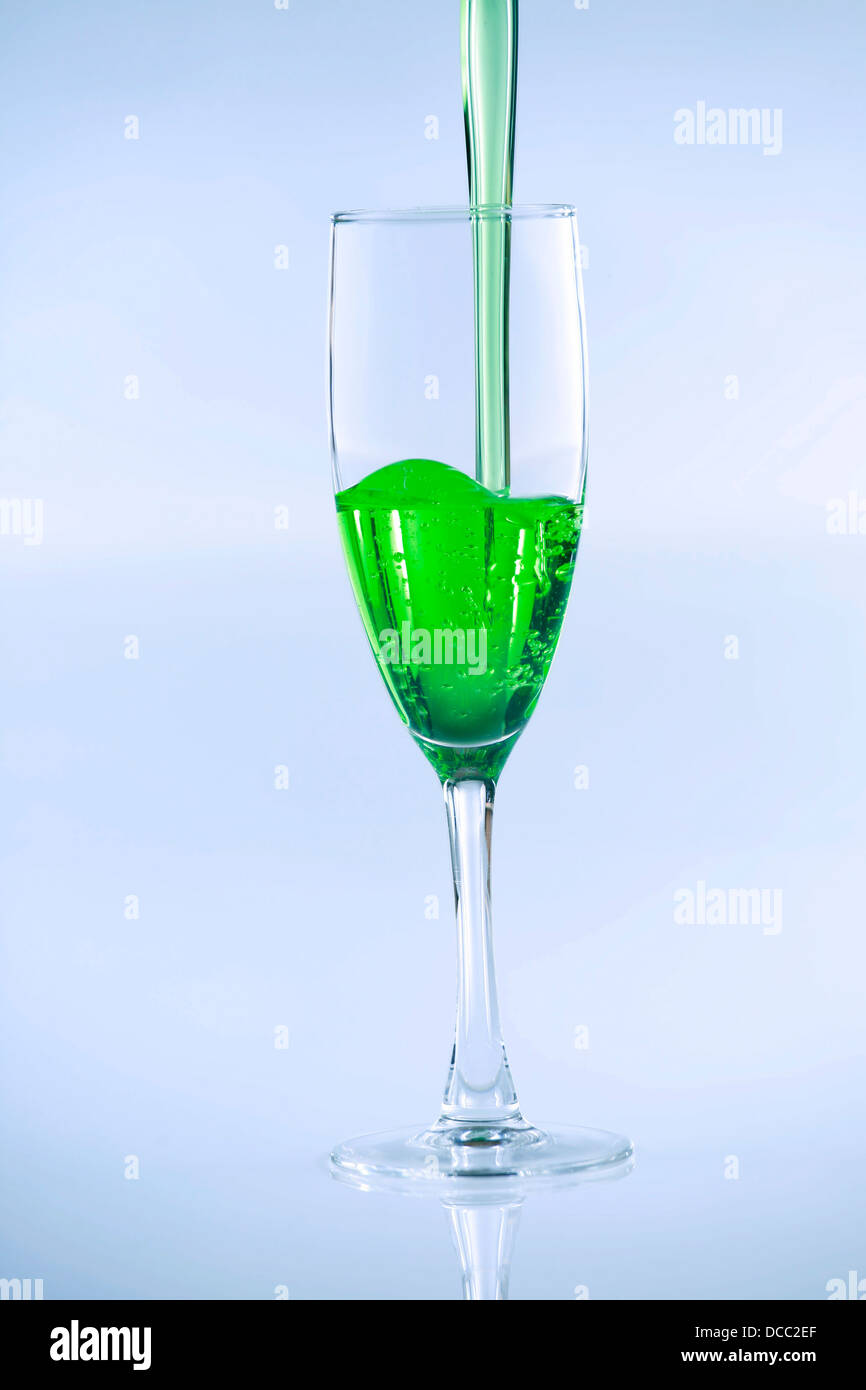 Green liquid drink being poured Stock Photo - Alamy