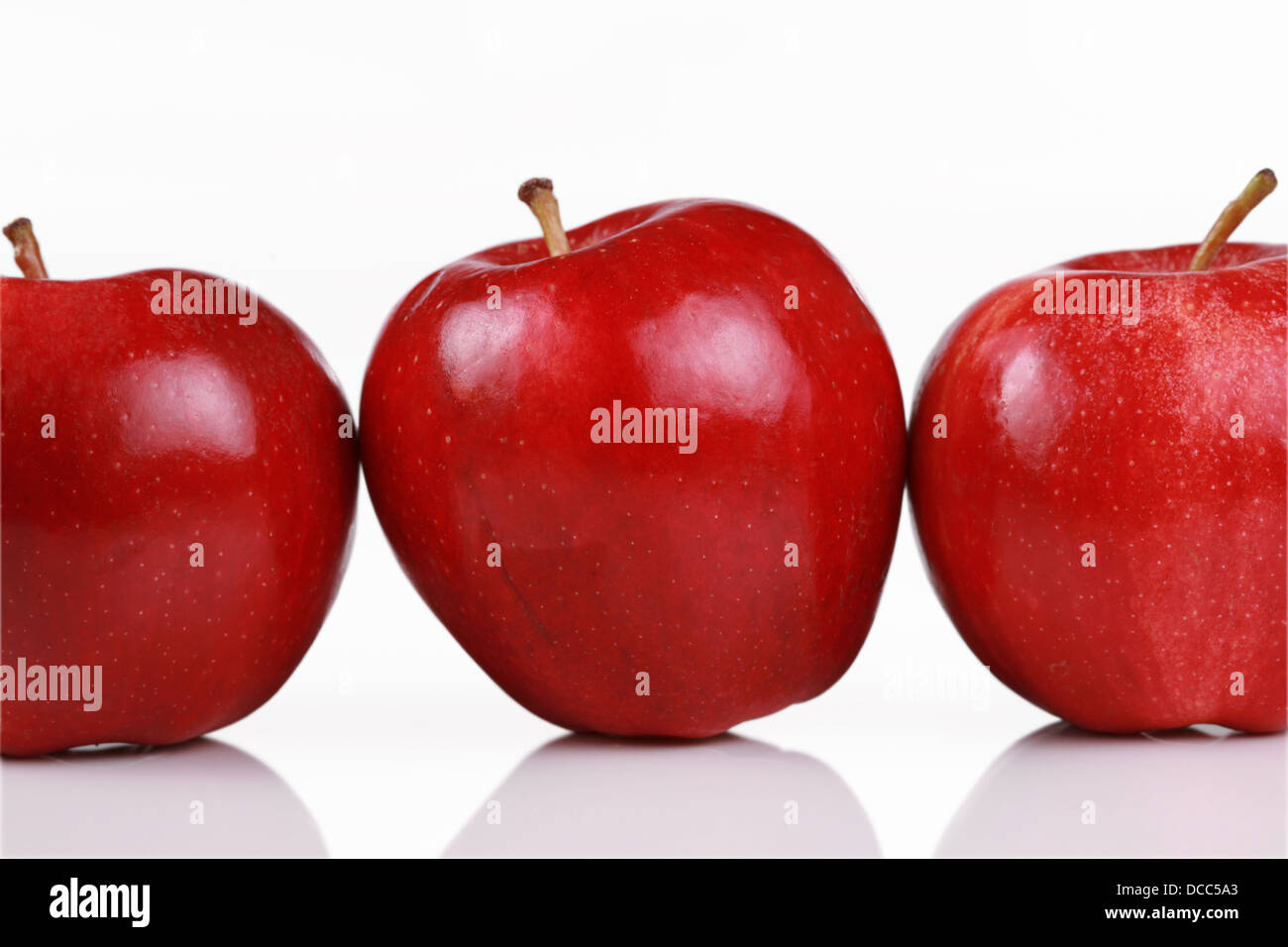 Three shiny red apples Stock Photo - Alamy