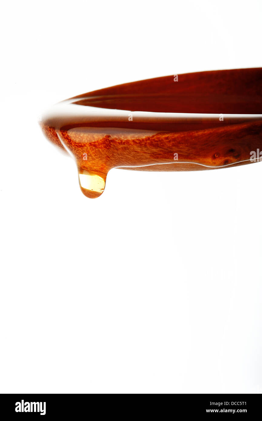 Honey dripping from a wooden spoon Stock Photo - Alamy