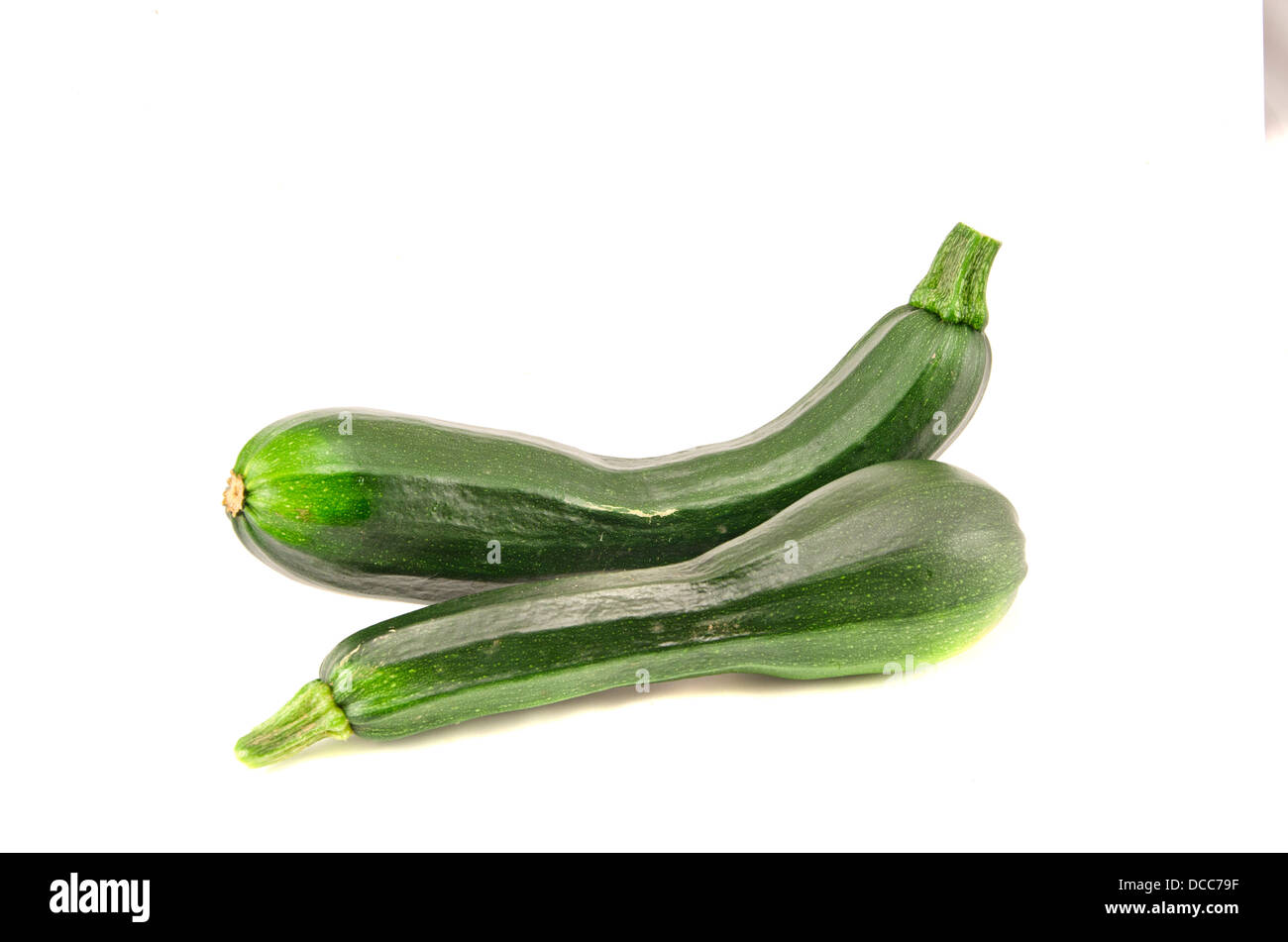 two fresh green courgette vegetable isolated on white Stock Photo - Alamy