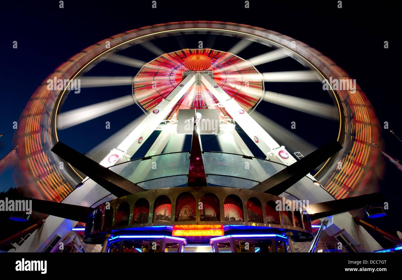 Hamburg, Germany. 14th Aug, 2013. A giant wheel turns at the funfair ...