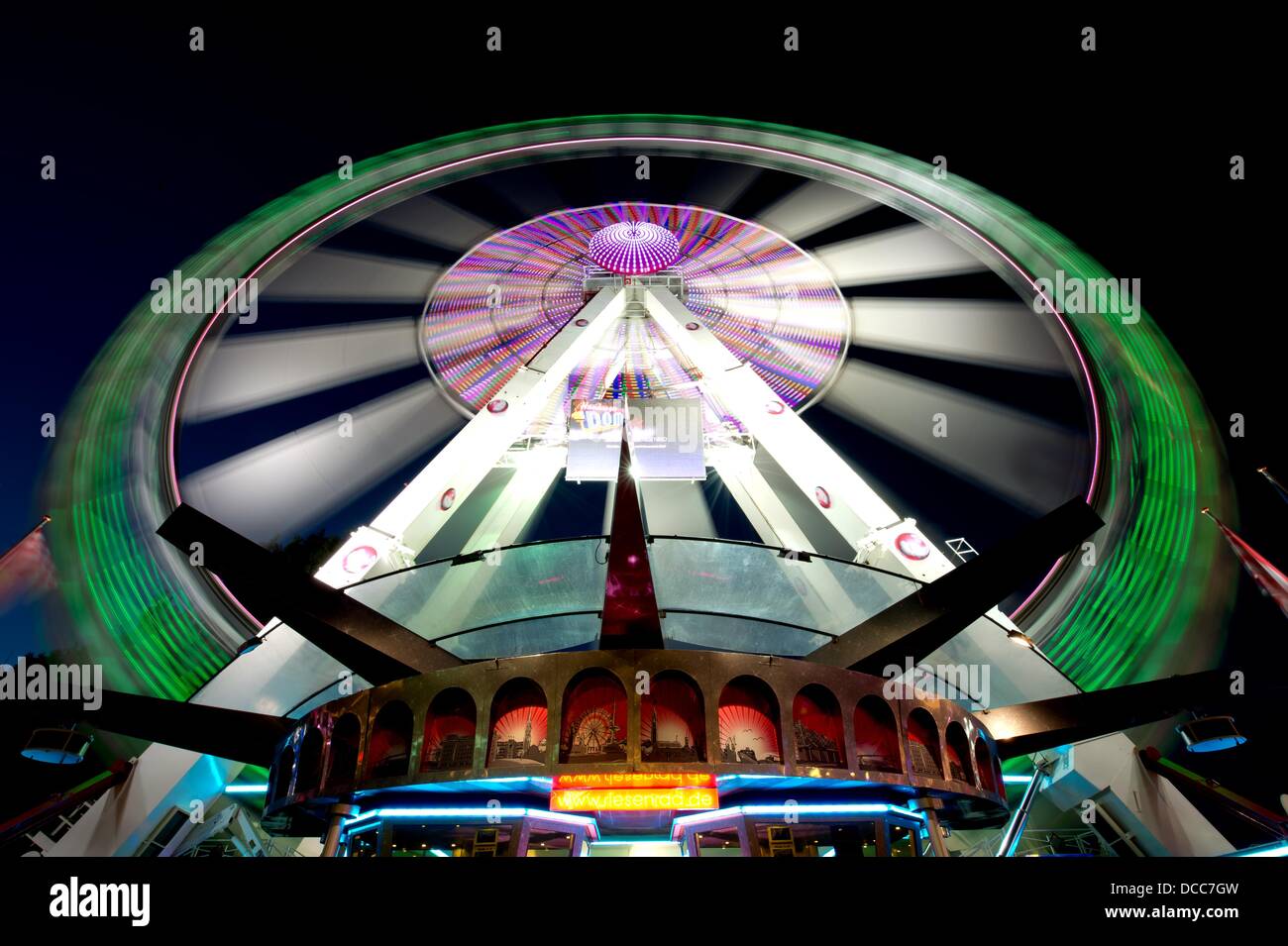 Hamburg, Germany. 14th Aug, 2013. A giant wheel turns at the funfair ...