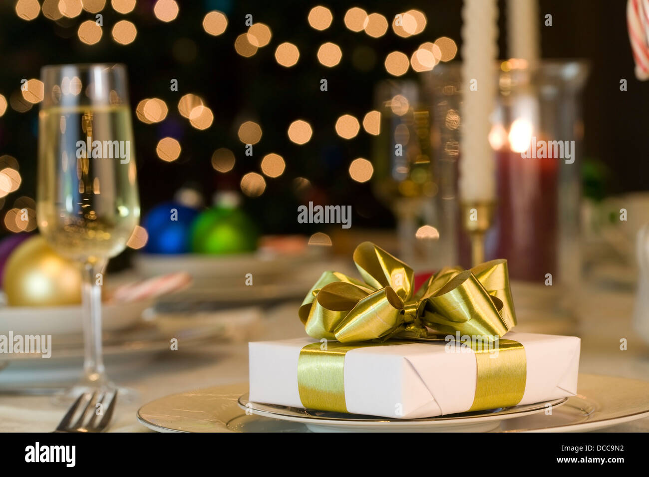 Gold ribbon gift on table Stock Photo - Alamy