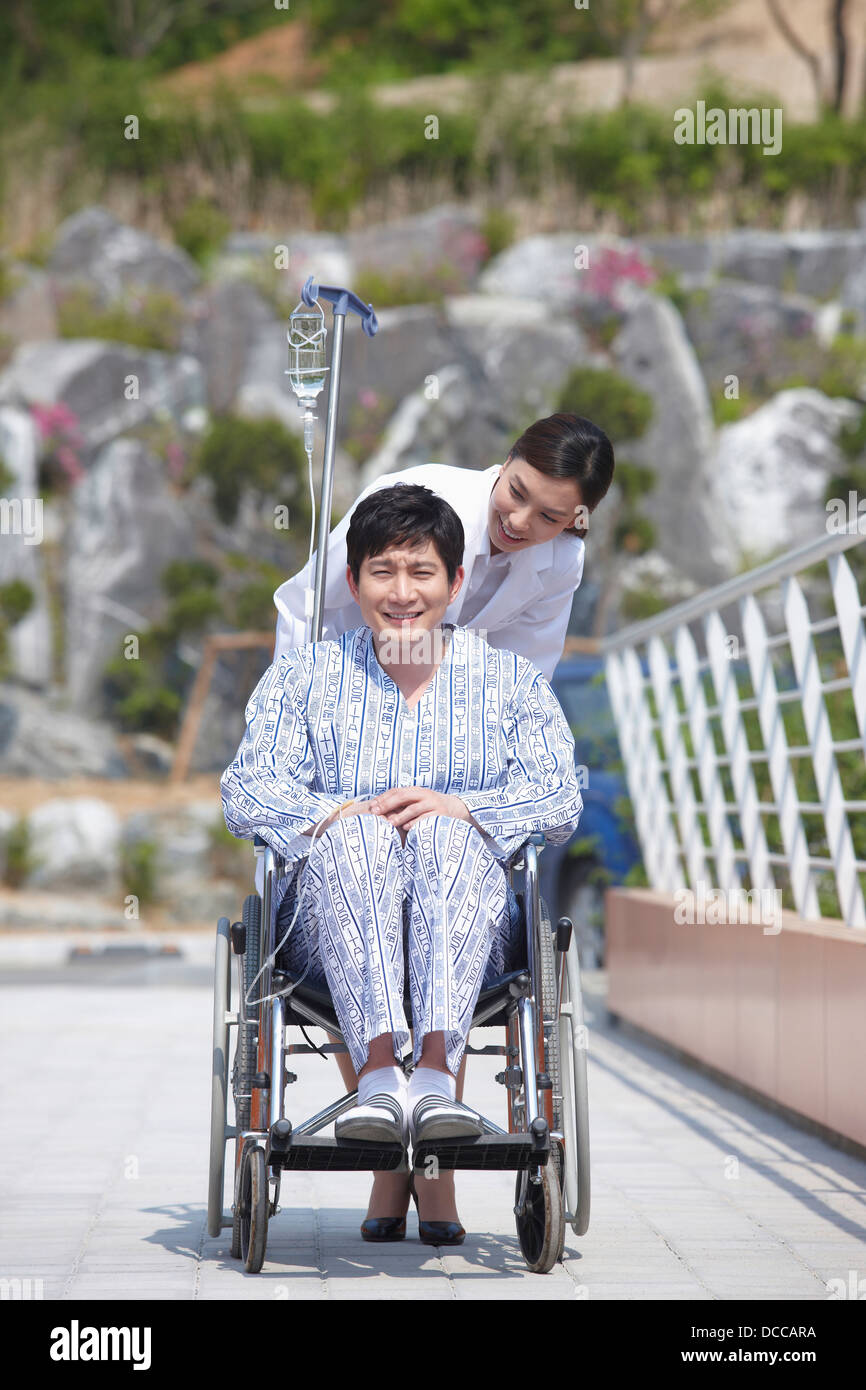 Doctor behind the patient hi-res stock photography and images - Alamy