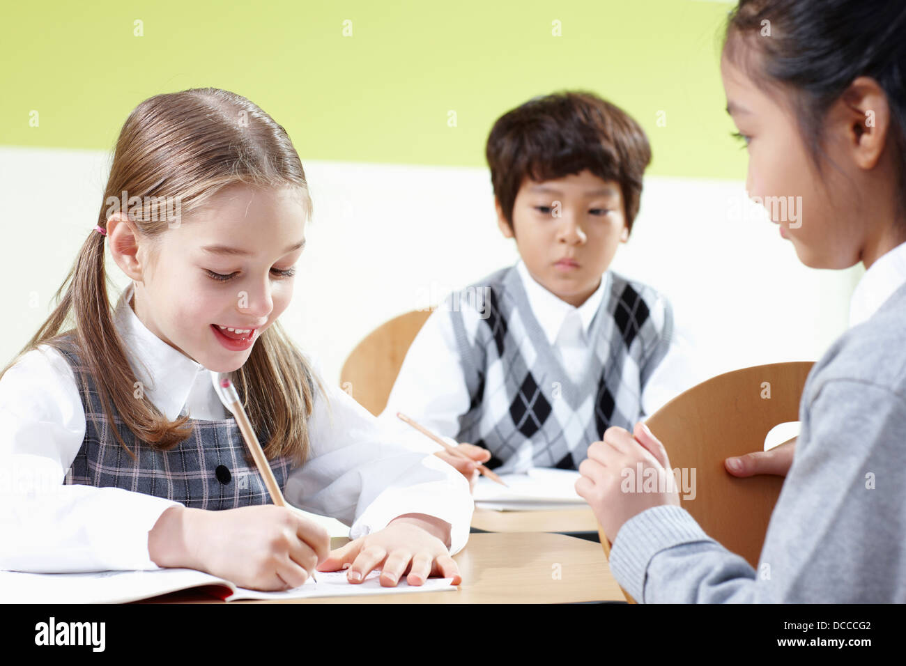 students helping each other in a classroom Stock Photo - Alamy