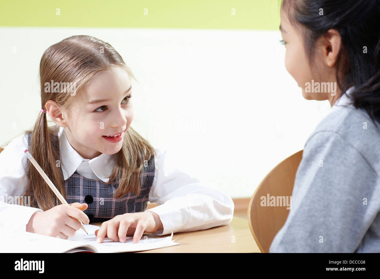students helping each other in a classroom Stock Photo - Alamy