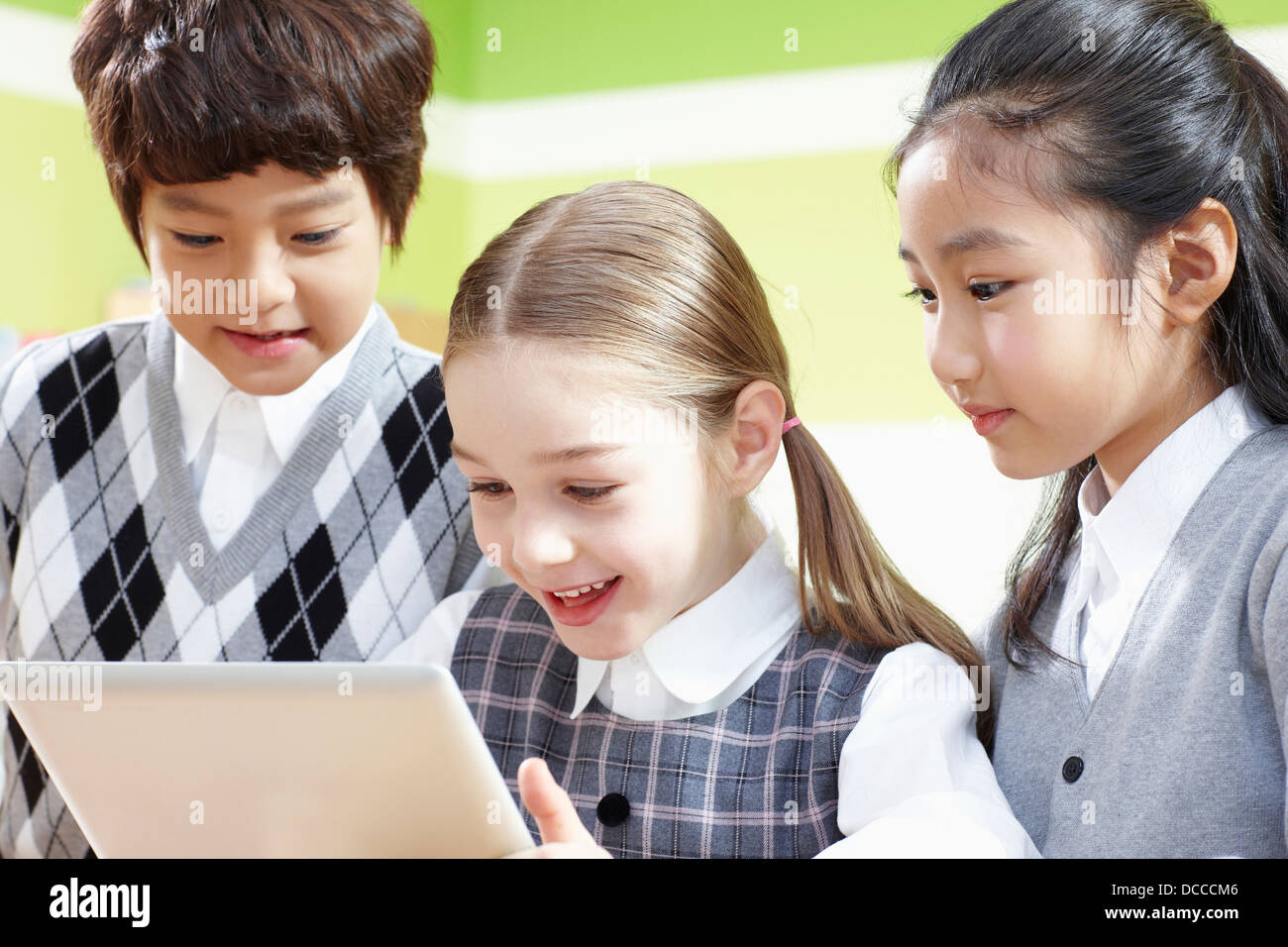students sharing a tablet PC in a classroom Stock Photo - Alamy