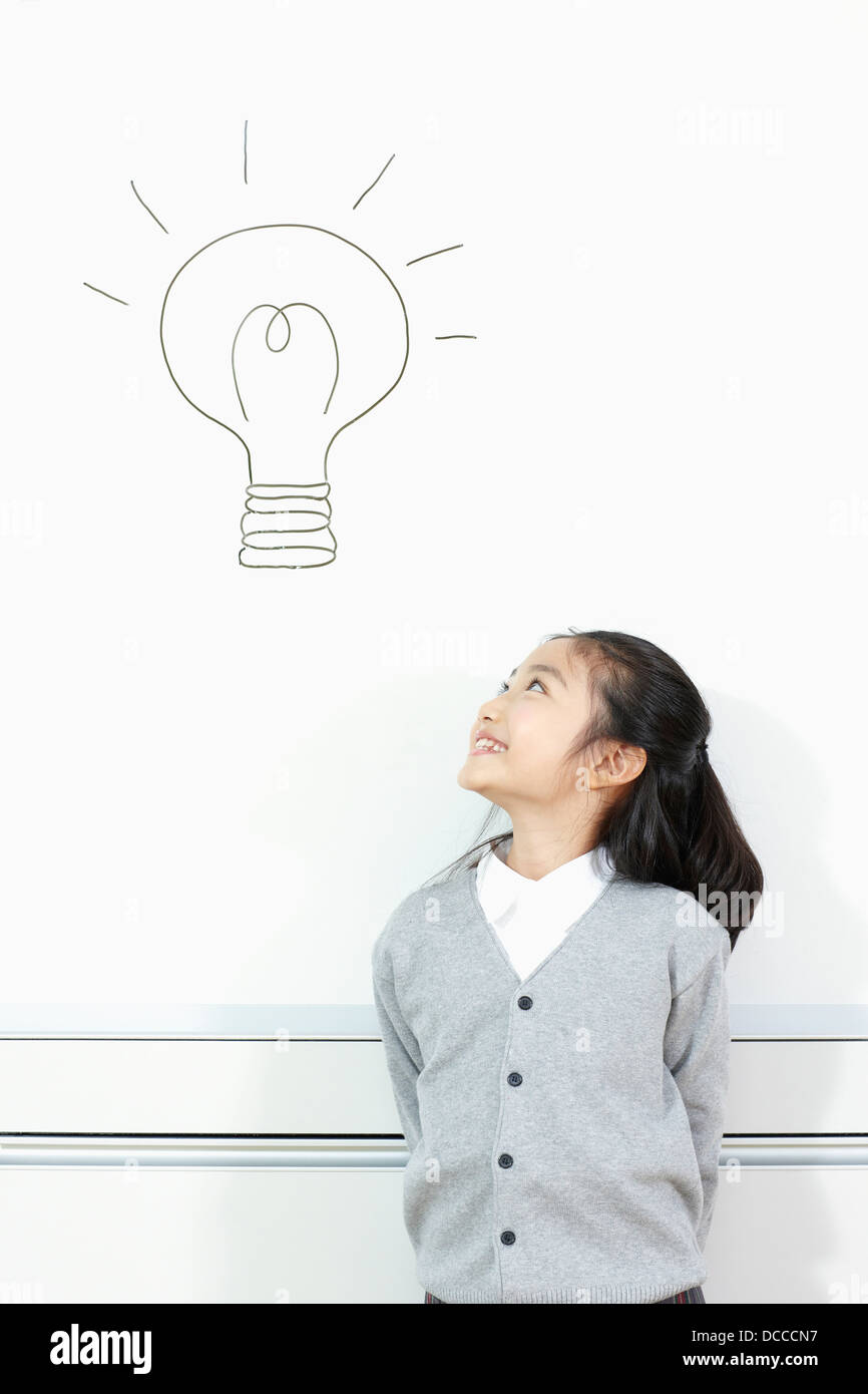 a student with a light bulb Stock Photo - Alamy