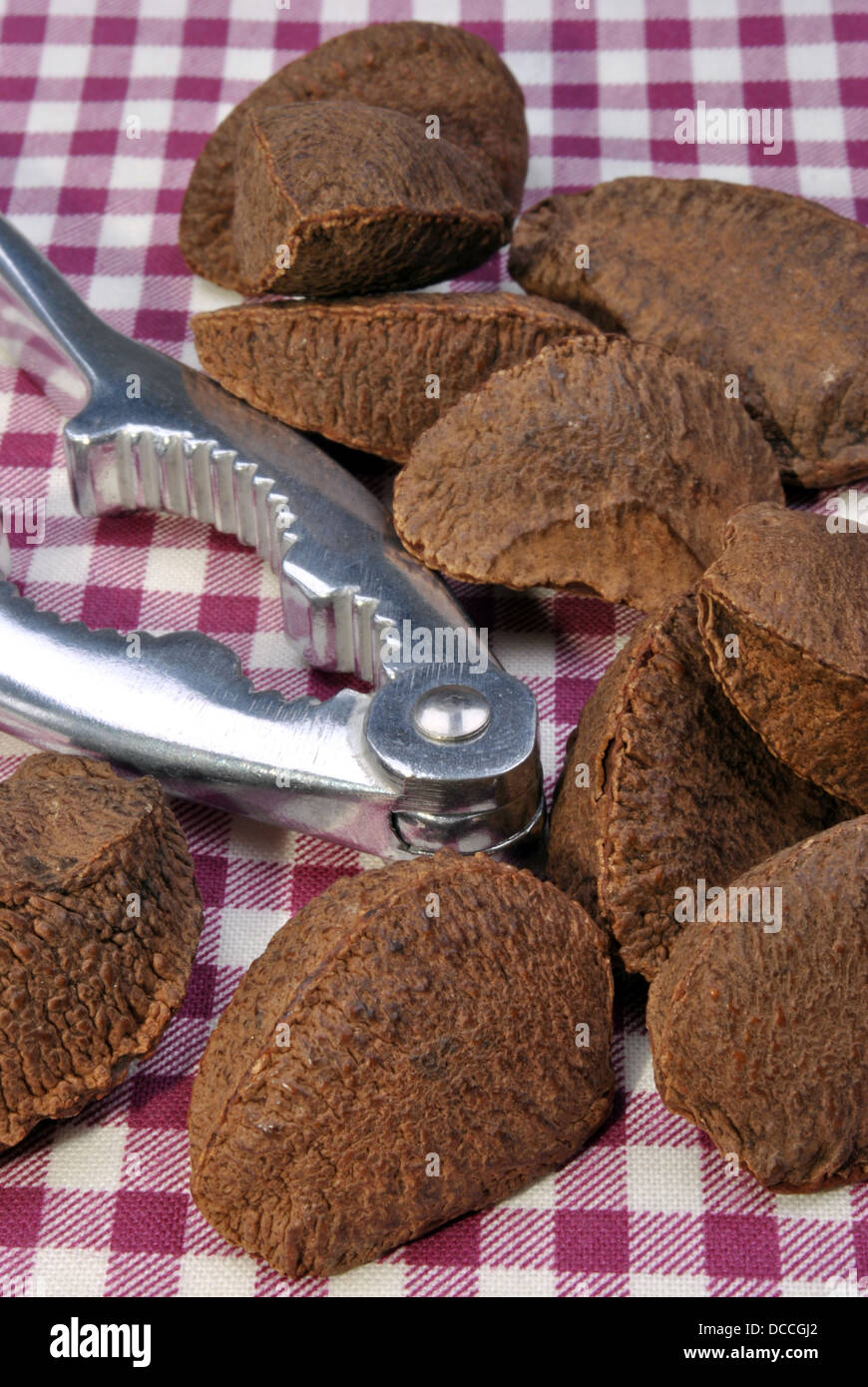 some organic brazil nuts and a nutcracker Stock Photo - Alamy