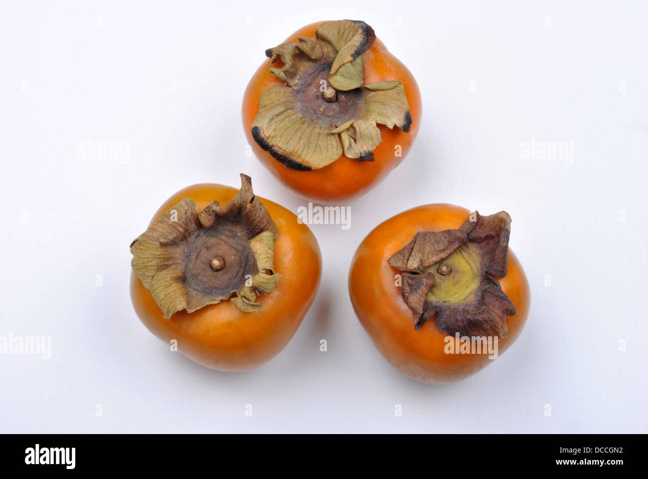 organic sharon fruit and a white background Stock Photo - Alamy