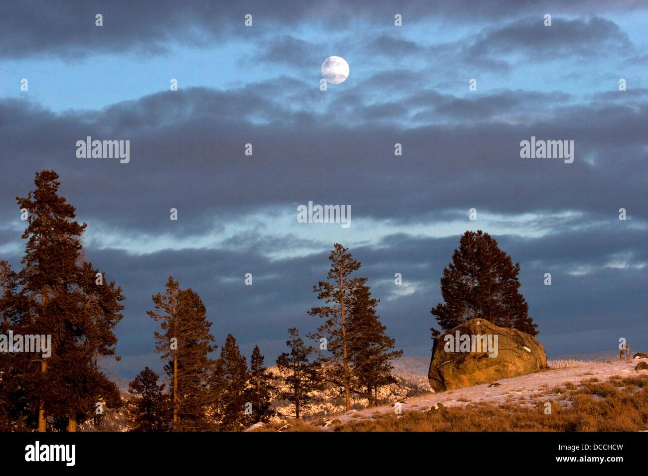 Full Moon Rises in clouds near sunset in Yellowstone National Park, USA ...