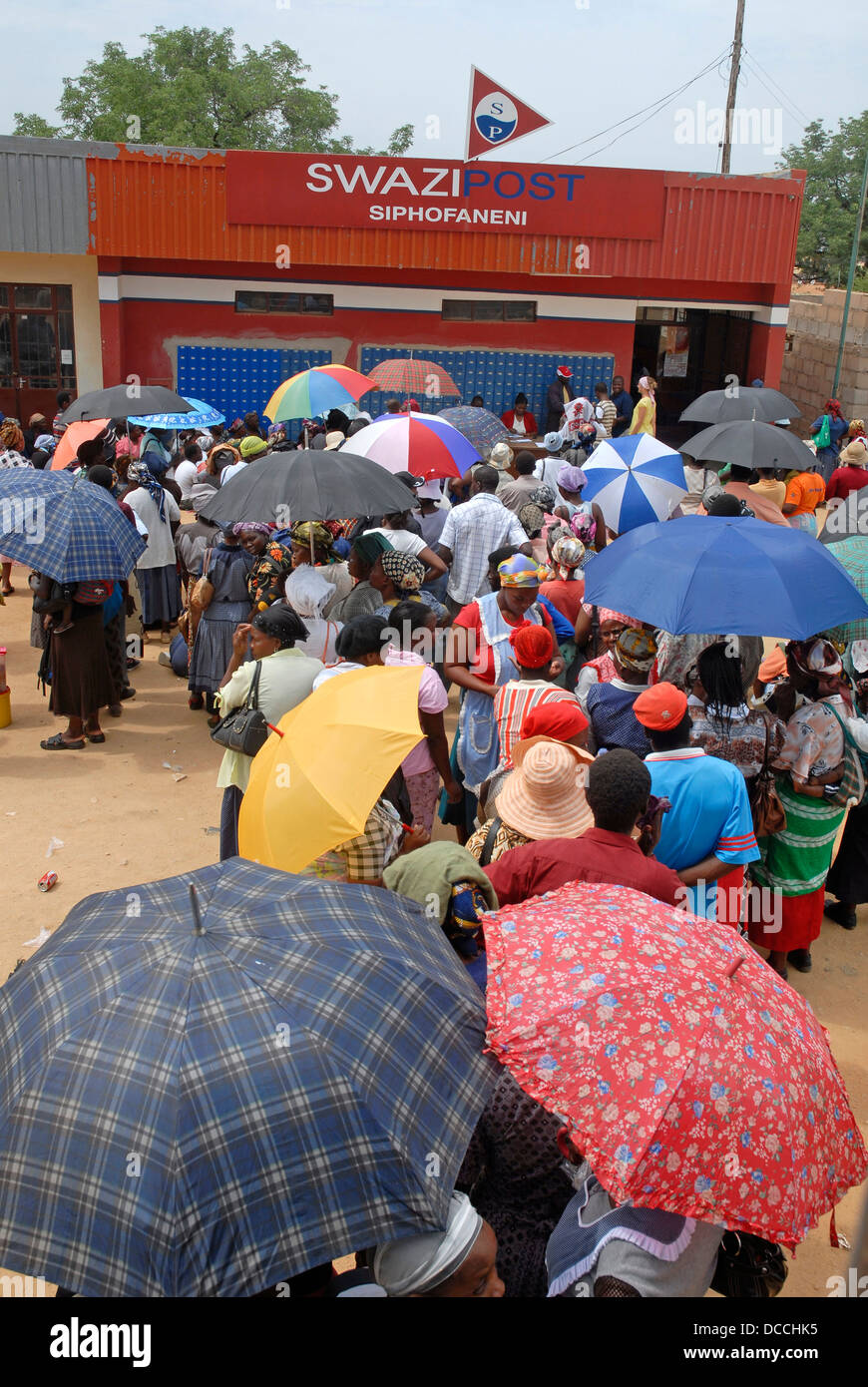 Cash transfer beneficiaries receiving cash at the Siphofaneni Post ...