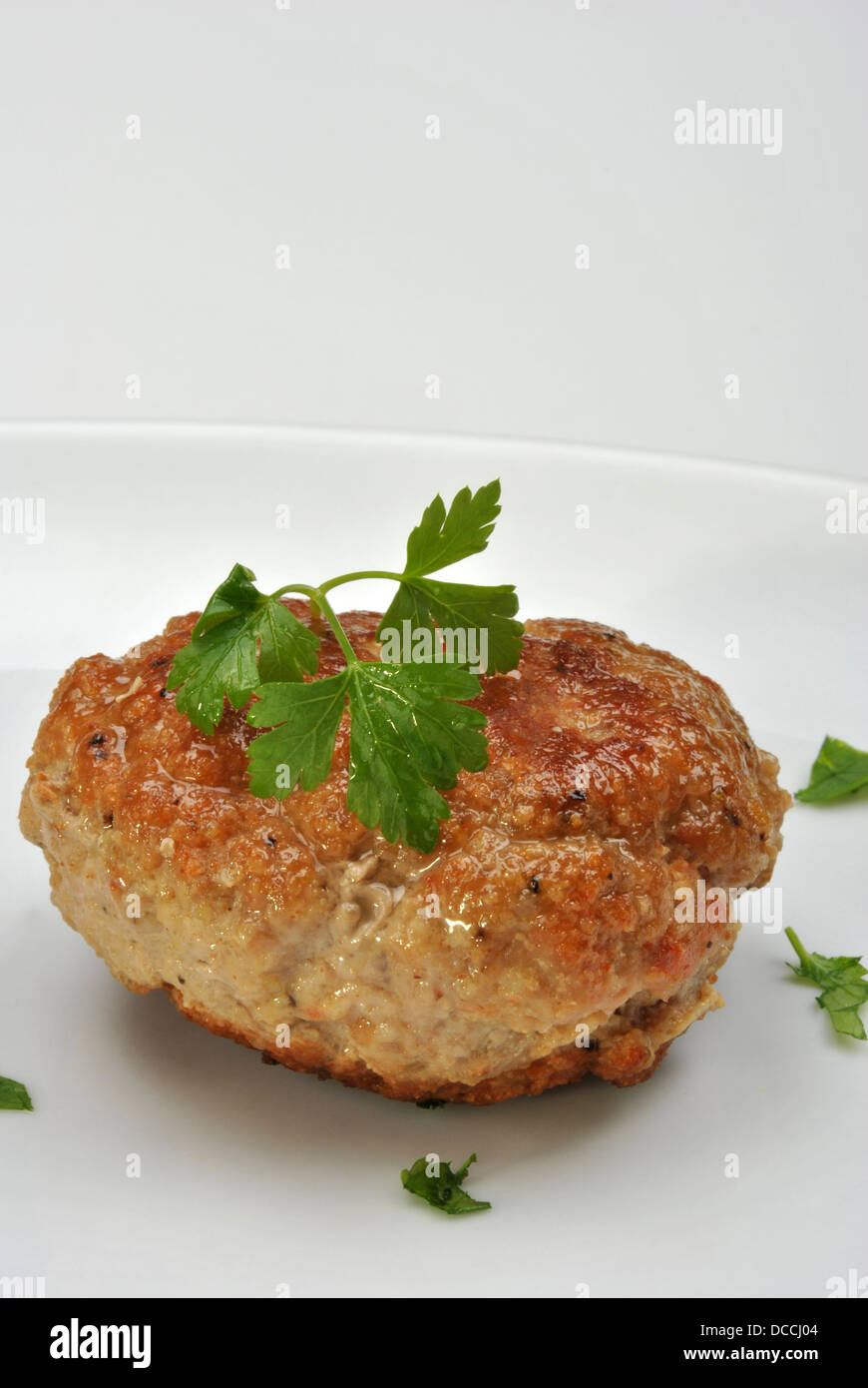 one meat ball with organic parsley on a white plate Stock Photo - Alamy
