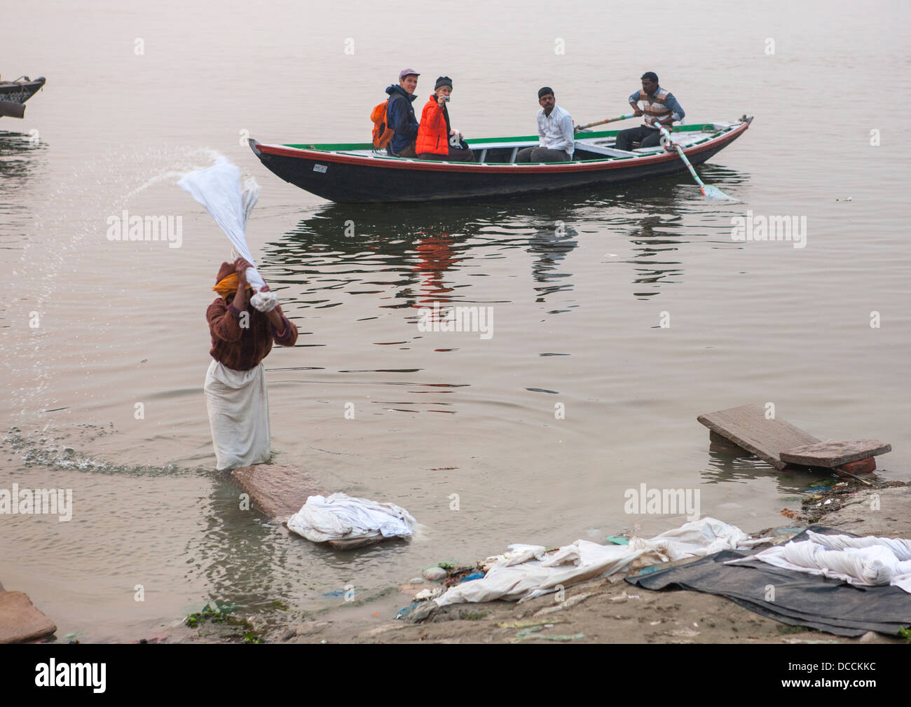 Men Washing Clothes In The Ganges River In Front Of Tourists, Varanasi ...