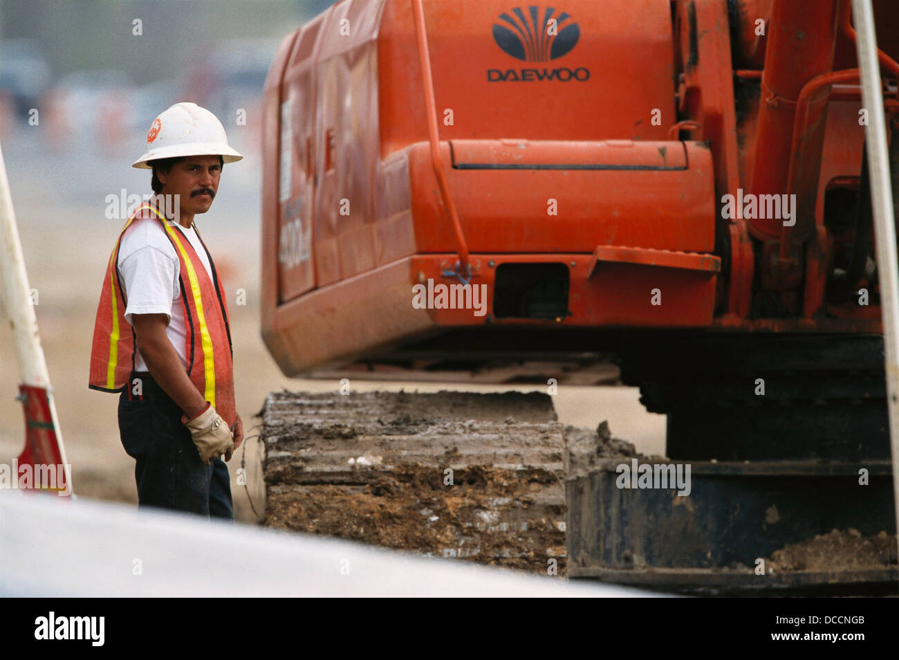 Construction worker and excavator. Texas. USA Stock Photo - Alamy