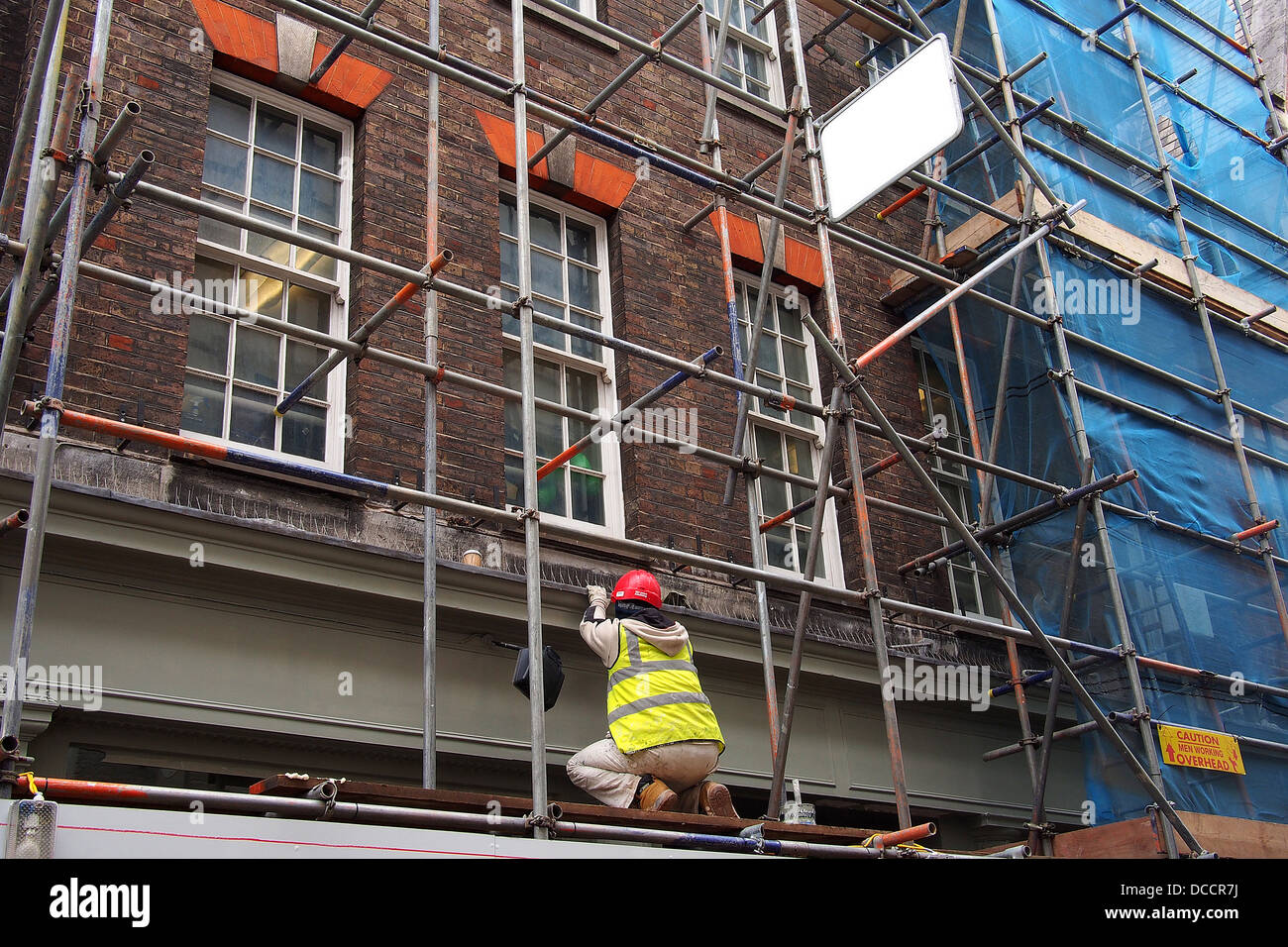 Construction worker in action. New building in progress Stock Photo - Alamy