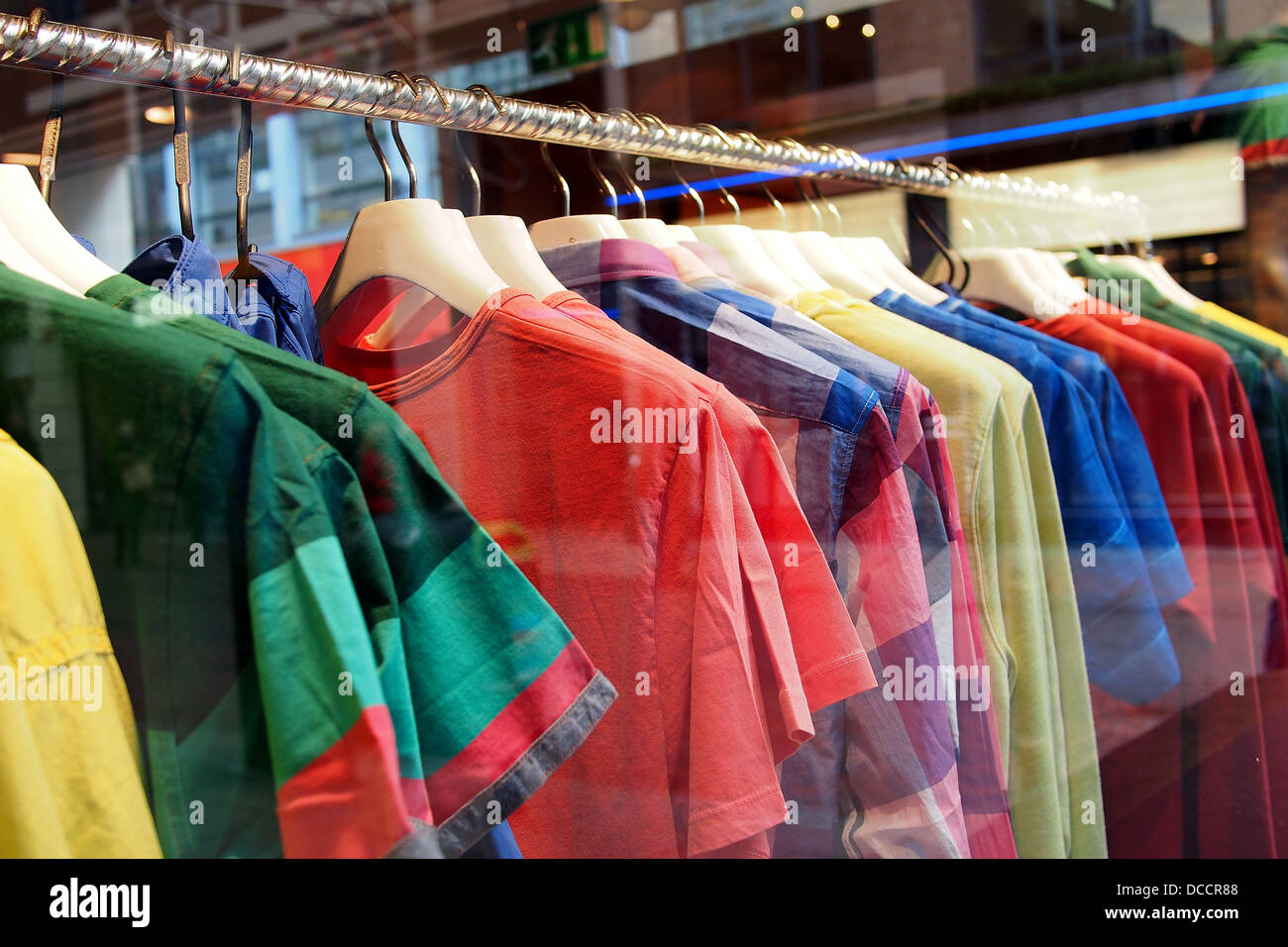 Row of fashion colorful clothing hanging a on display Stock Photo - Alamy
