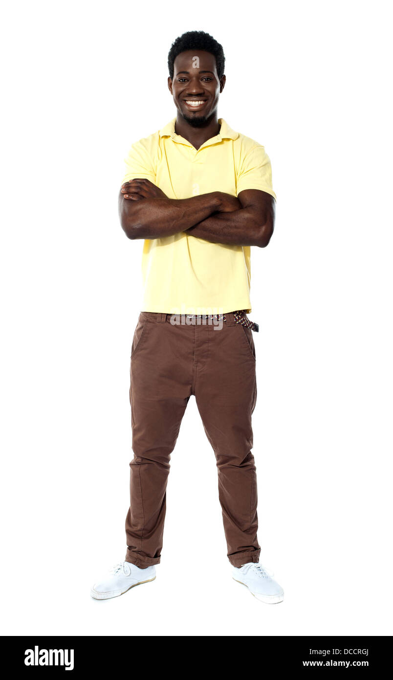 Full length portrait smiling african guy standing with arms crossed ...