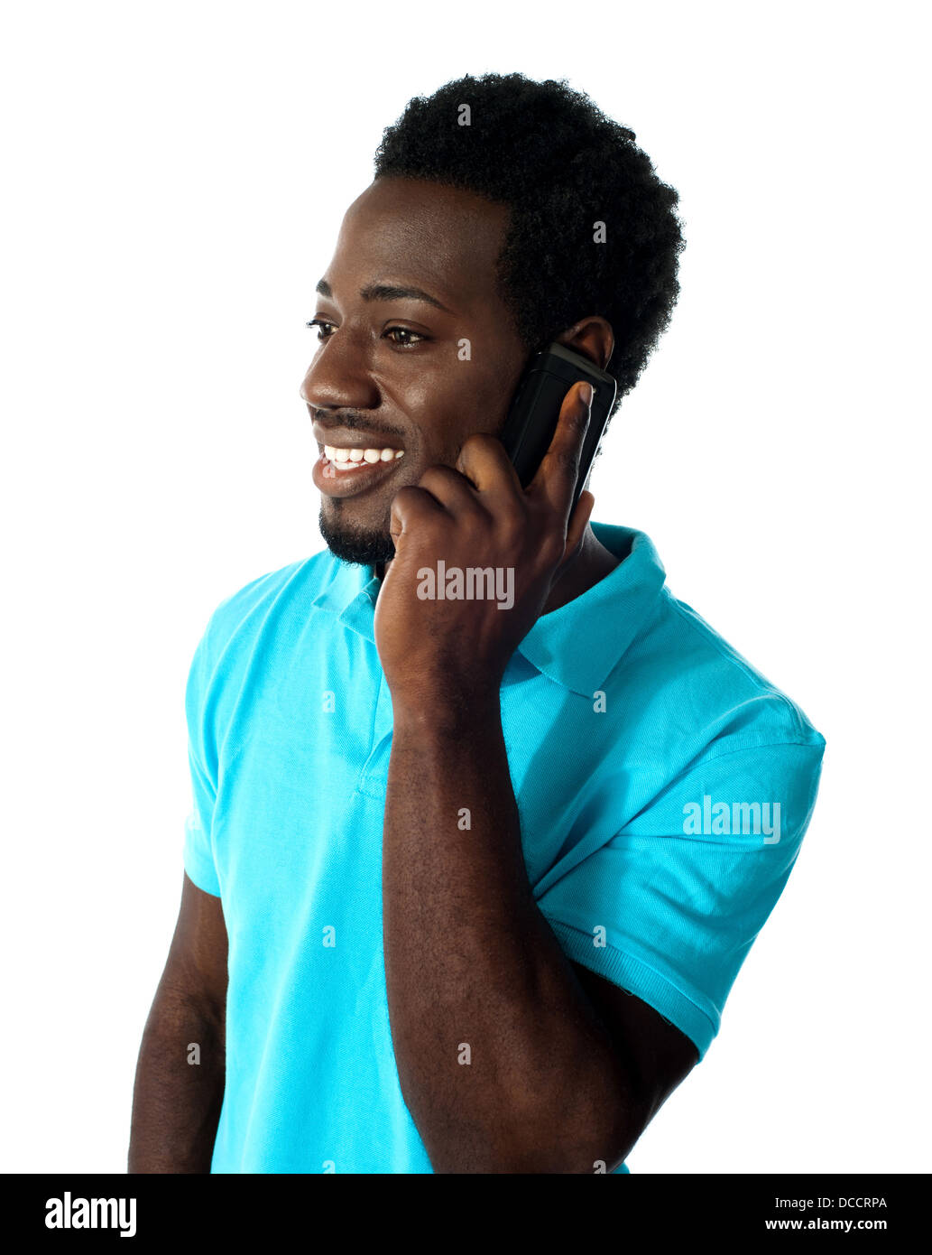 African guy communicating via cellphone and looking away Stock Photo ...