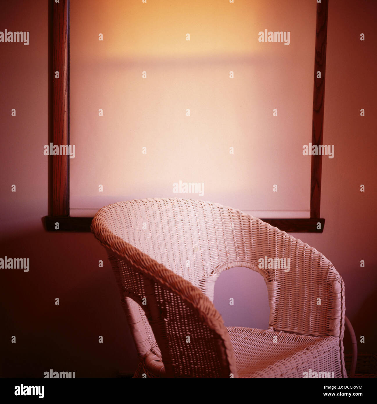 Wicker chair by window Stock Photo - Alamy