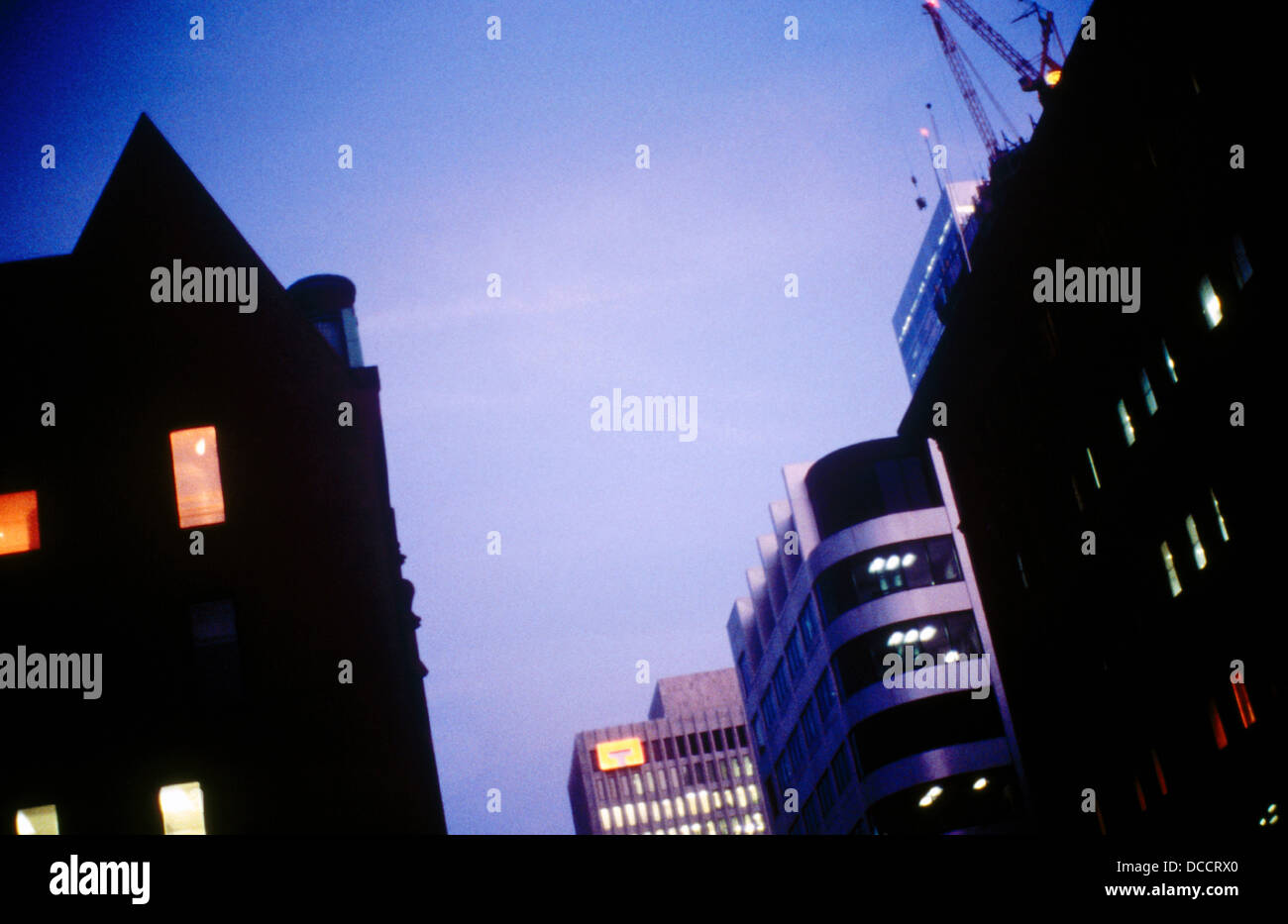 One window light on at dusk/dawn in the city Stock Photo - Alamy