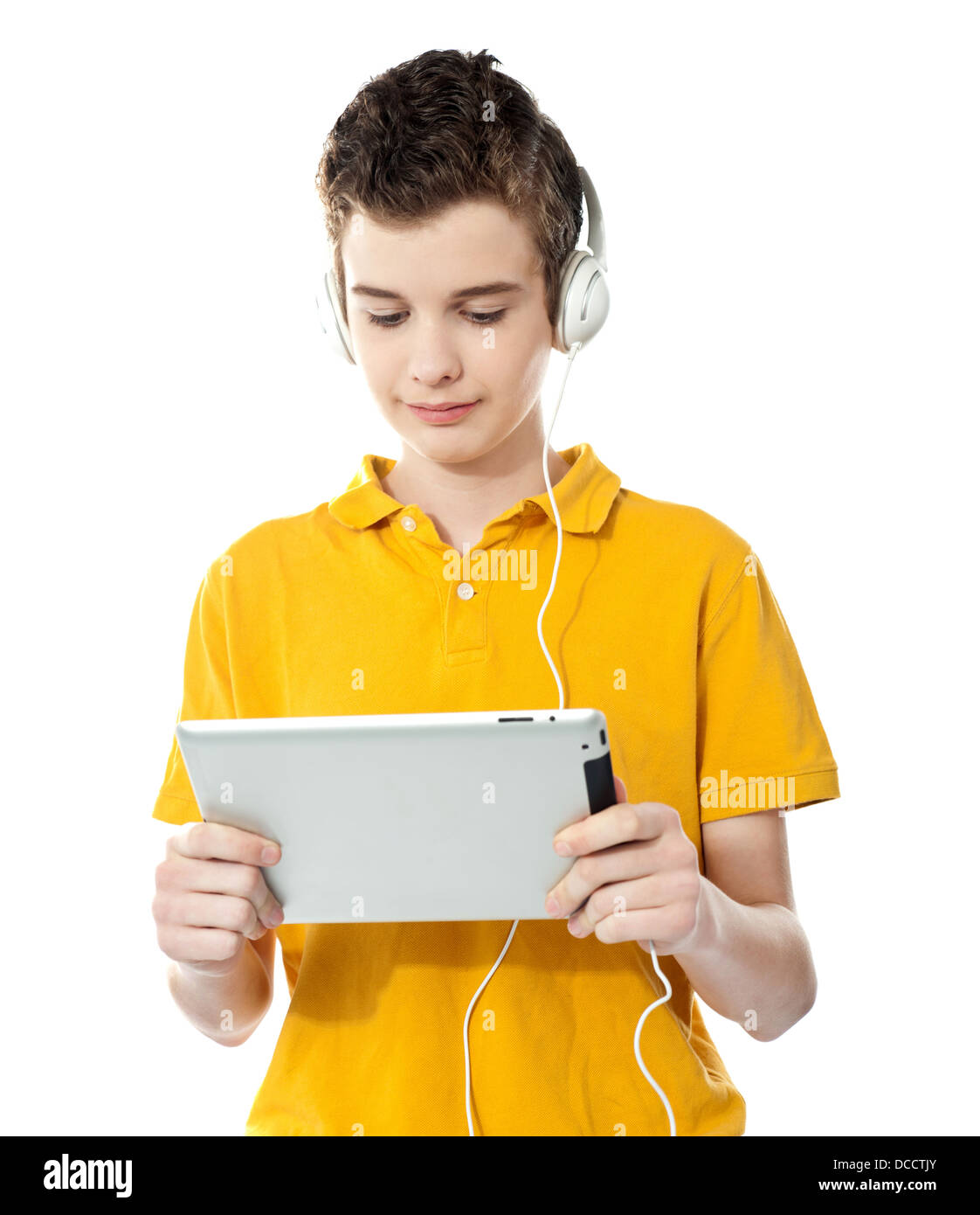Boy listening to music on tablet pc through headphones Stock Photo - Alamy