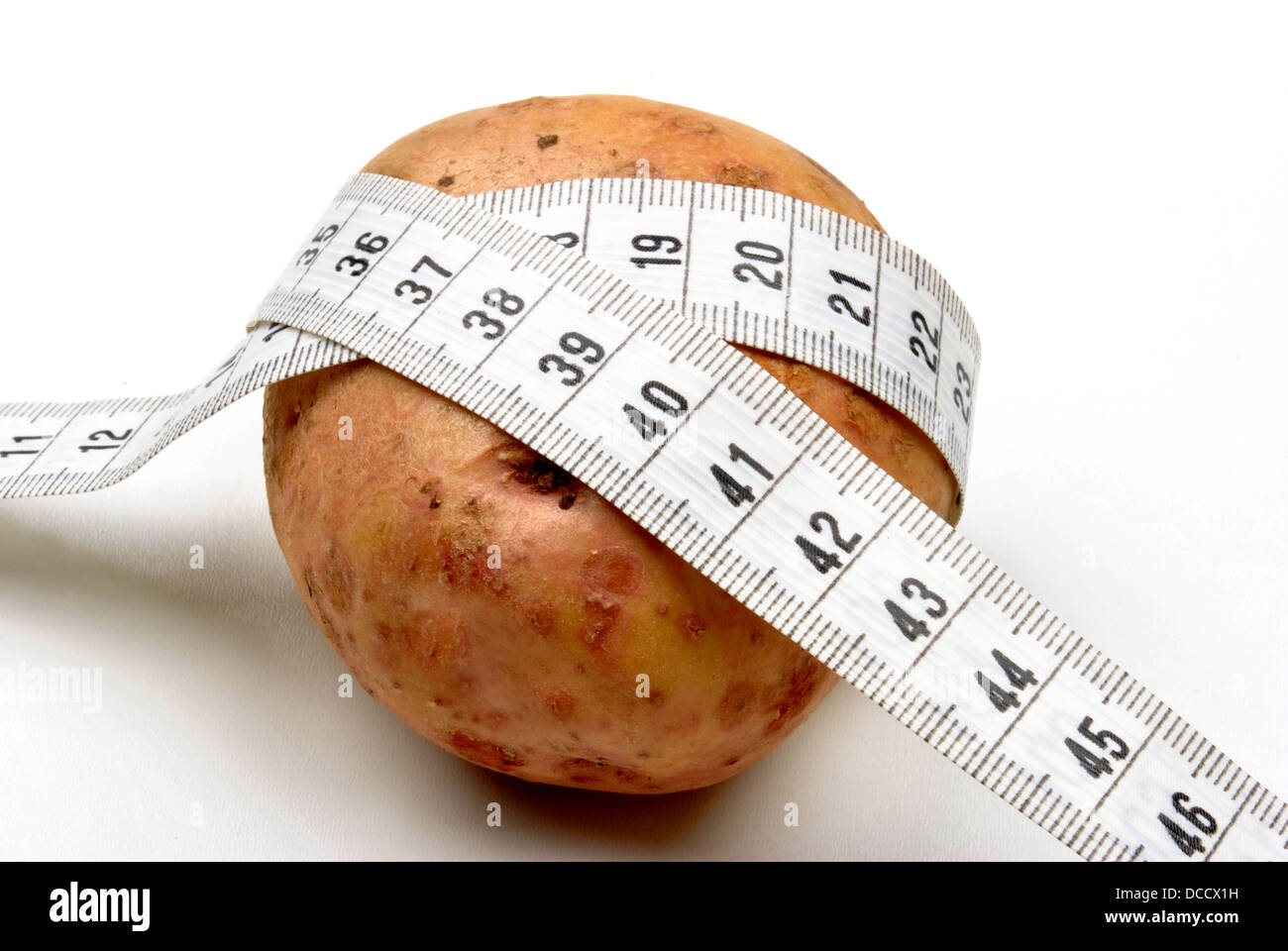 fresh organic potato and cenitmeter tape measure Stock Photo - Alamy