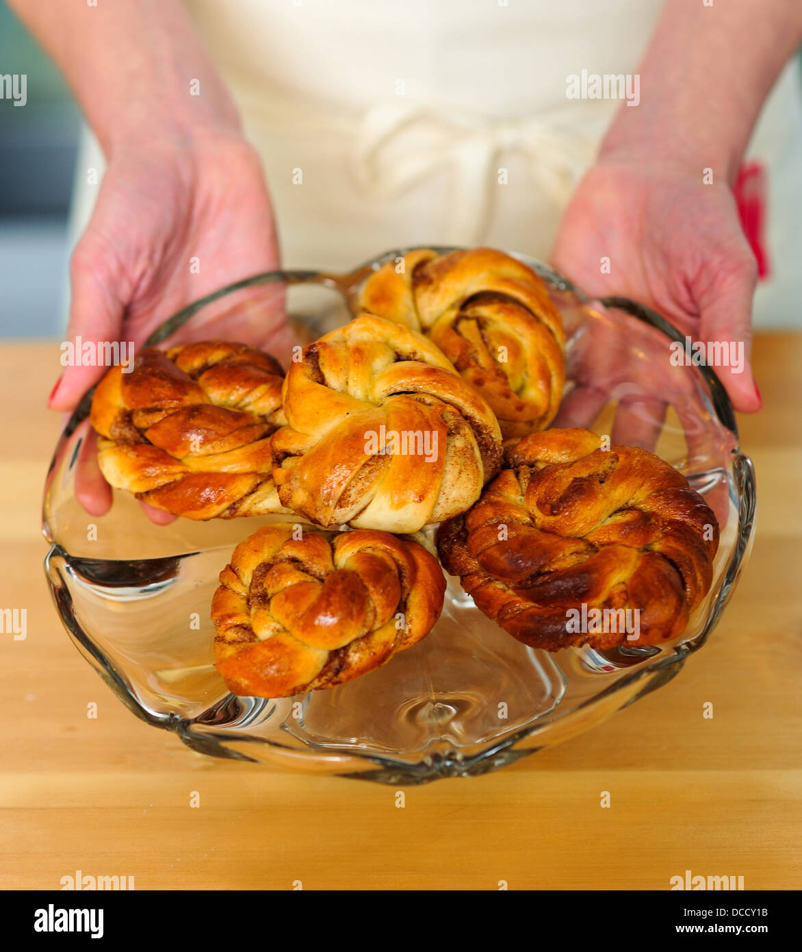 Female hands showing fresh rolls in a glass bowl Stock Photo - Alamy